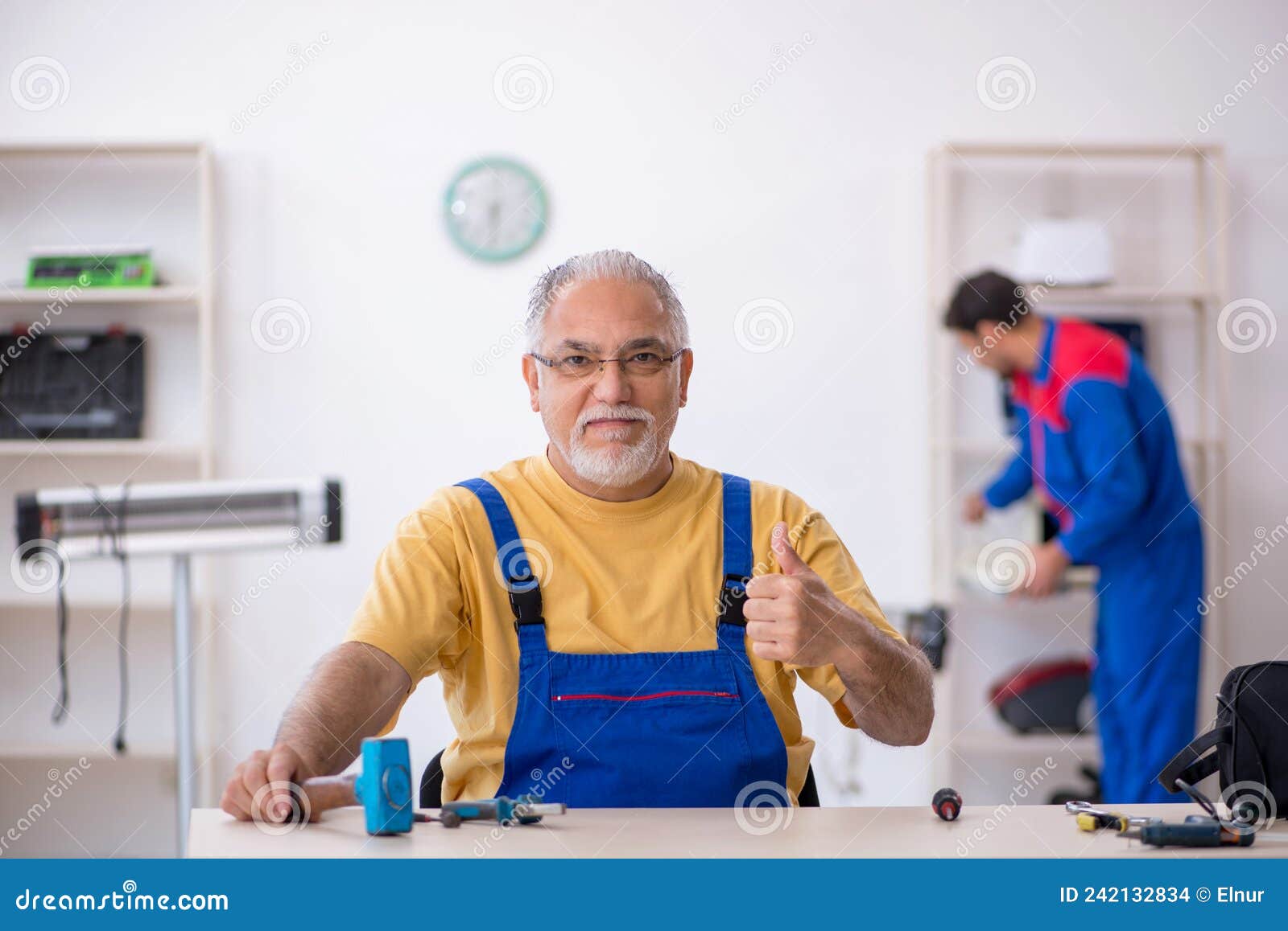 Two Male Repairmen Working at Workshop Stock Photo - Image of checking ...