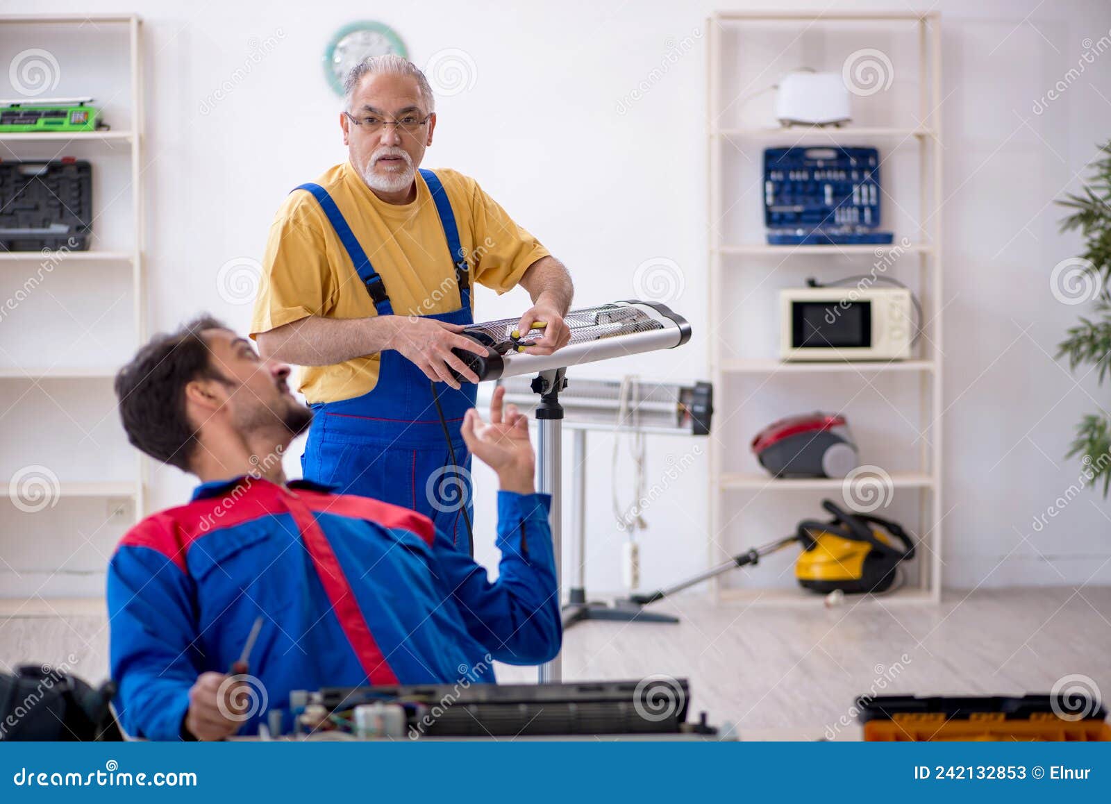 Two Male Repairmen Working at Workshop Stock Image - Image of workshop ...