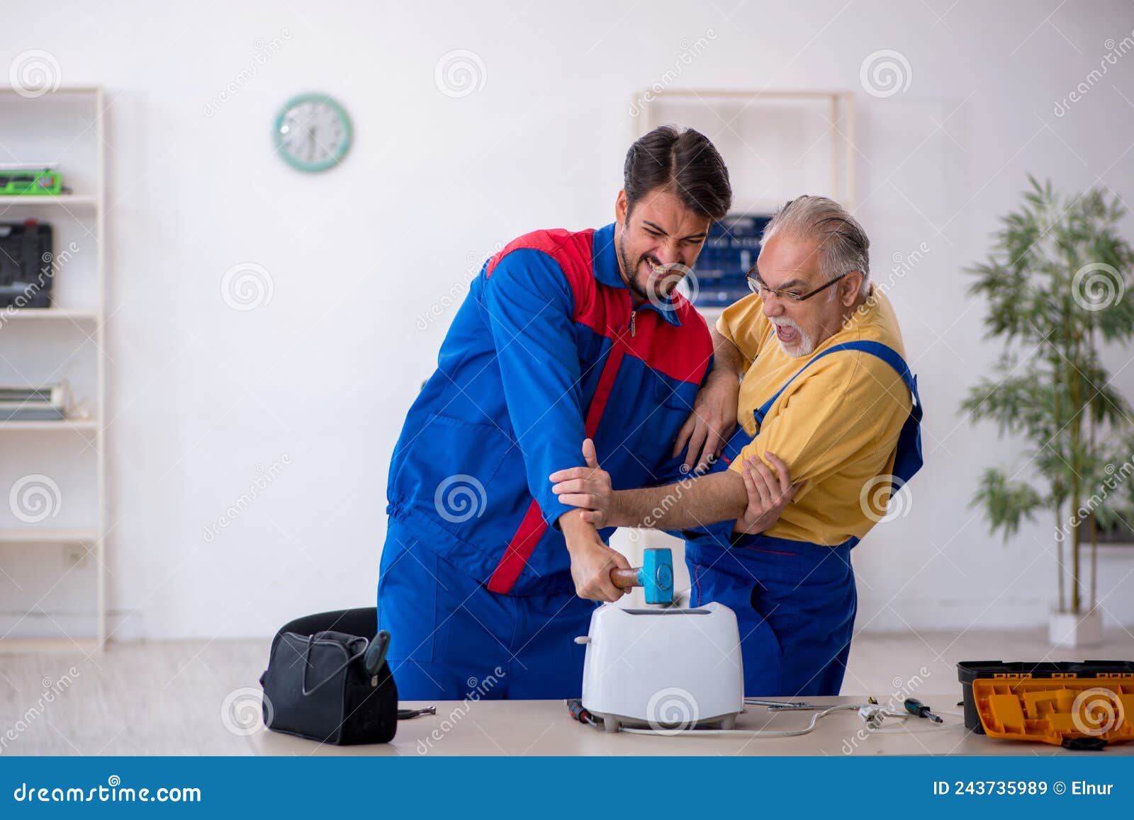 Two Male Repairmen Working at Workshop Stock Image - Image of ...
