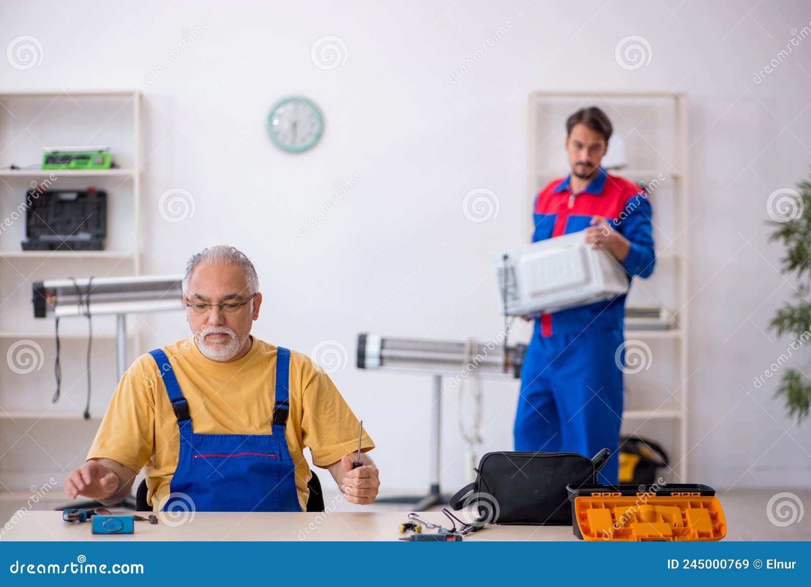 Two Male Repairmen Working at Workshop Stock Image - Image of cooker ...