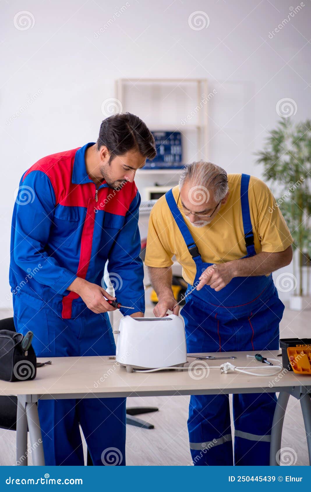 Two Male Repairmen Working at Workshop Stock Image - Image of repairman ...