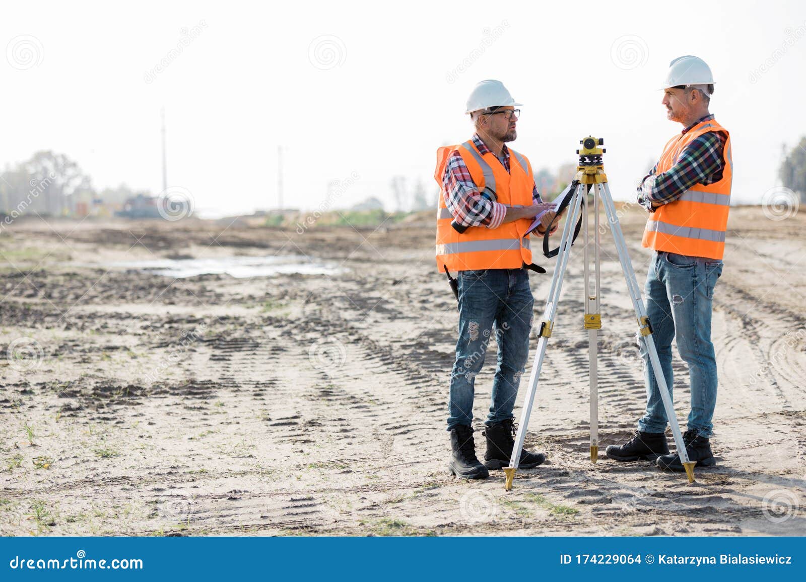Road Construction Workers Using Measuring Device on the Field Stock ...