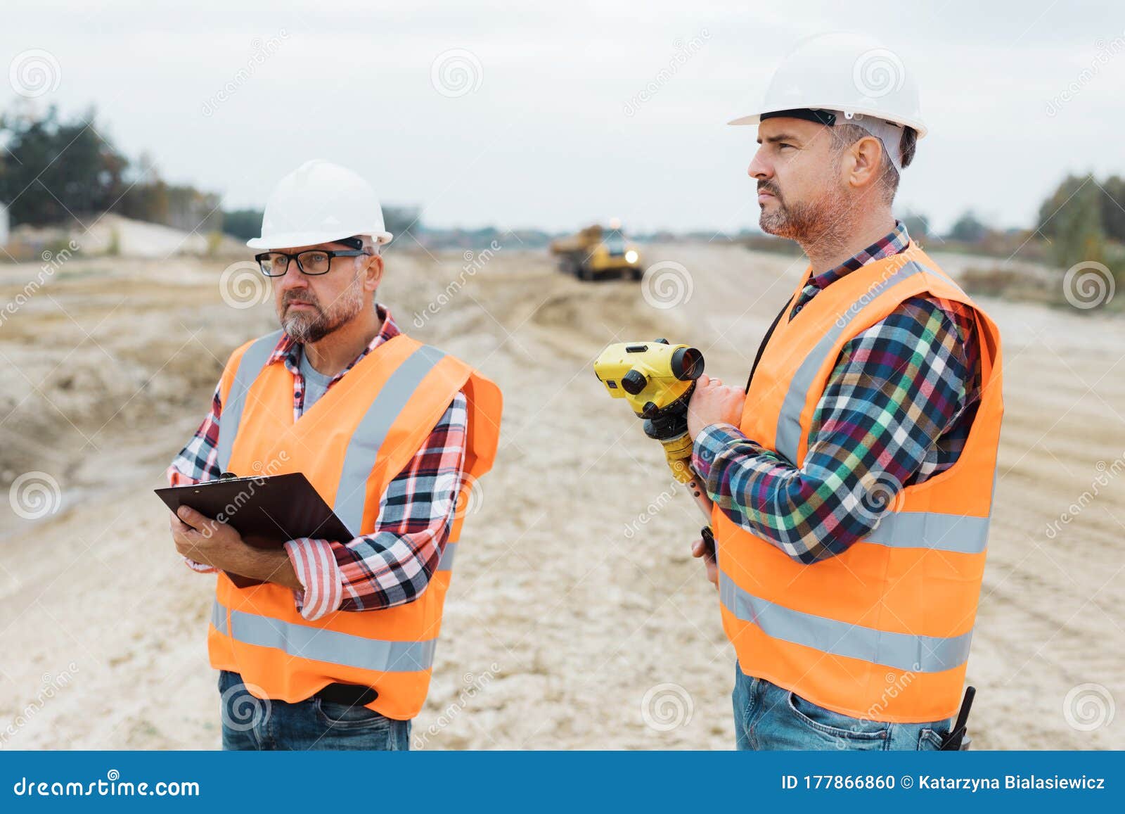 Road Construction Workers Using Measuring Device on the Field Stock ...