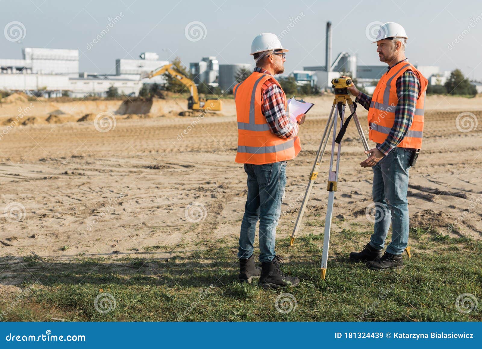 Road Construction Workers Using Measuring Device on the Field Stock ...
