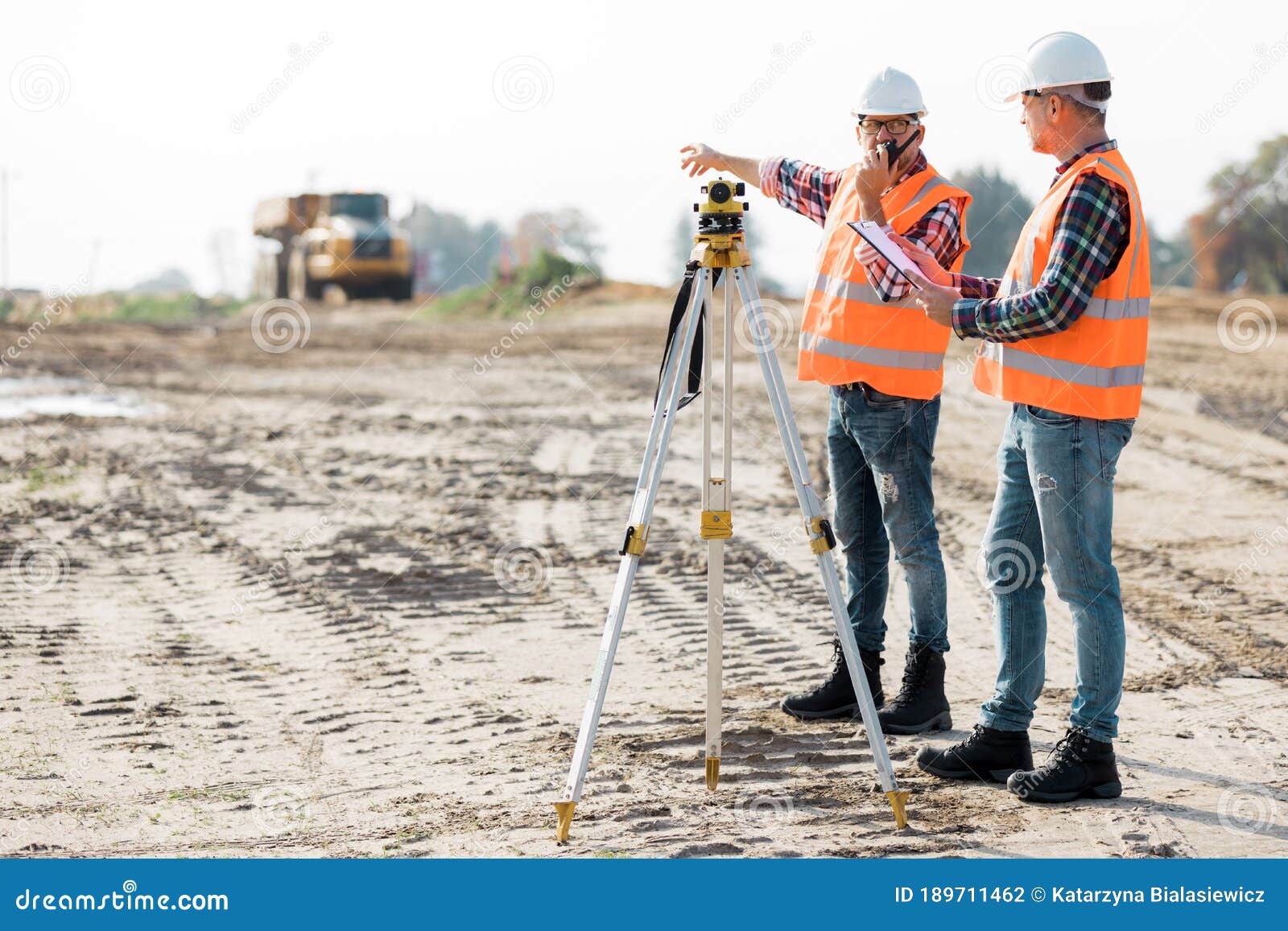 Road Construction Workers Using Measuring Device on the Field Stock ...