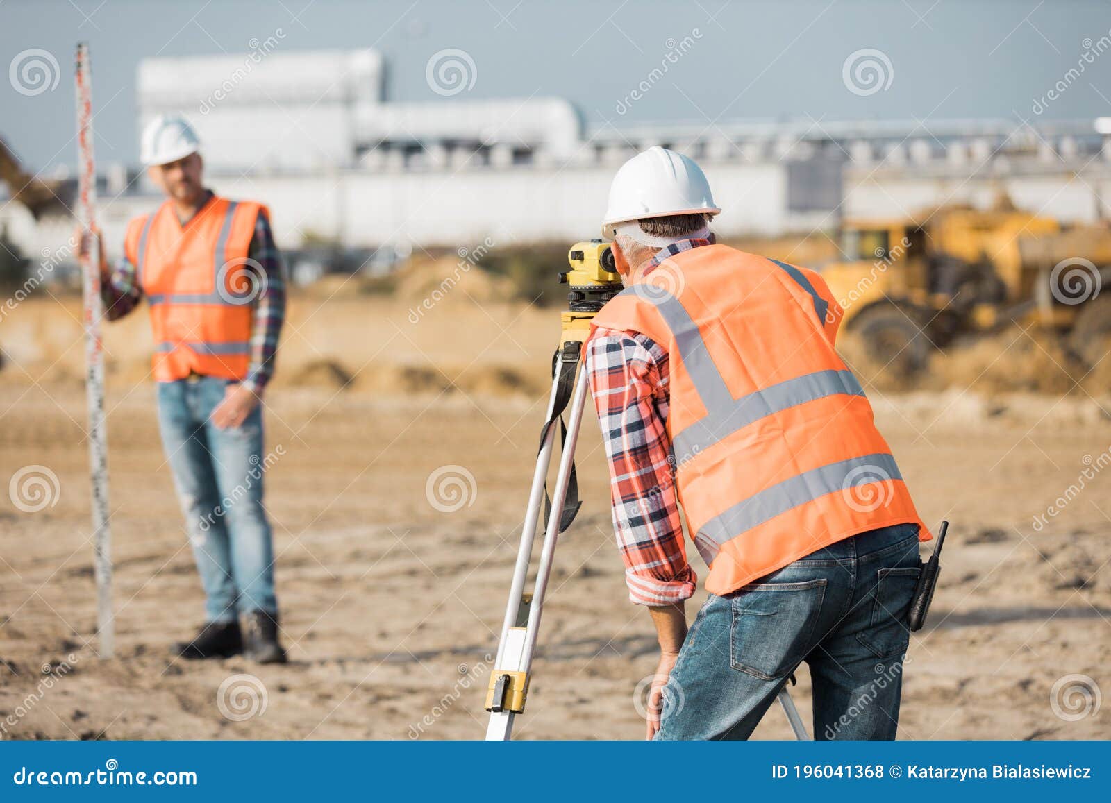 Road Construction Workers Using Measuring Device on the Field Stock ...