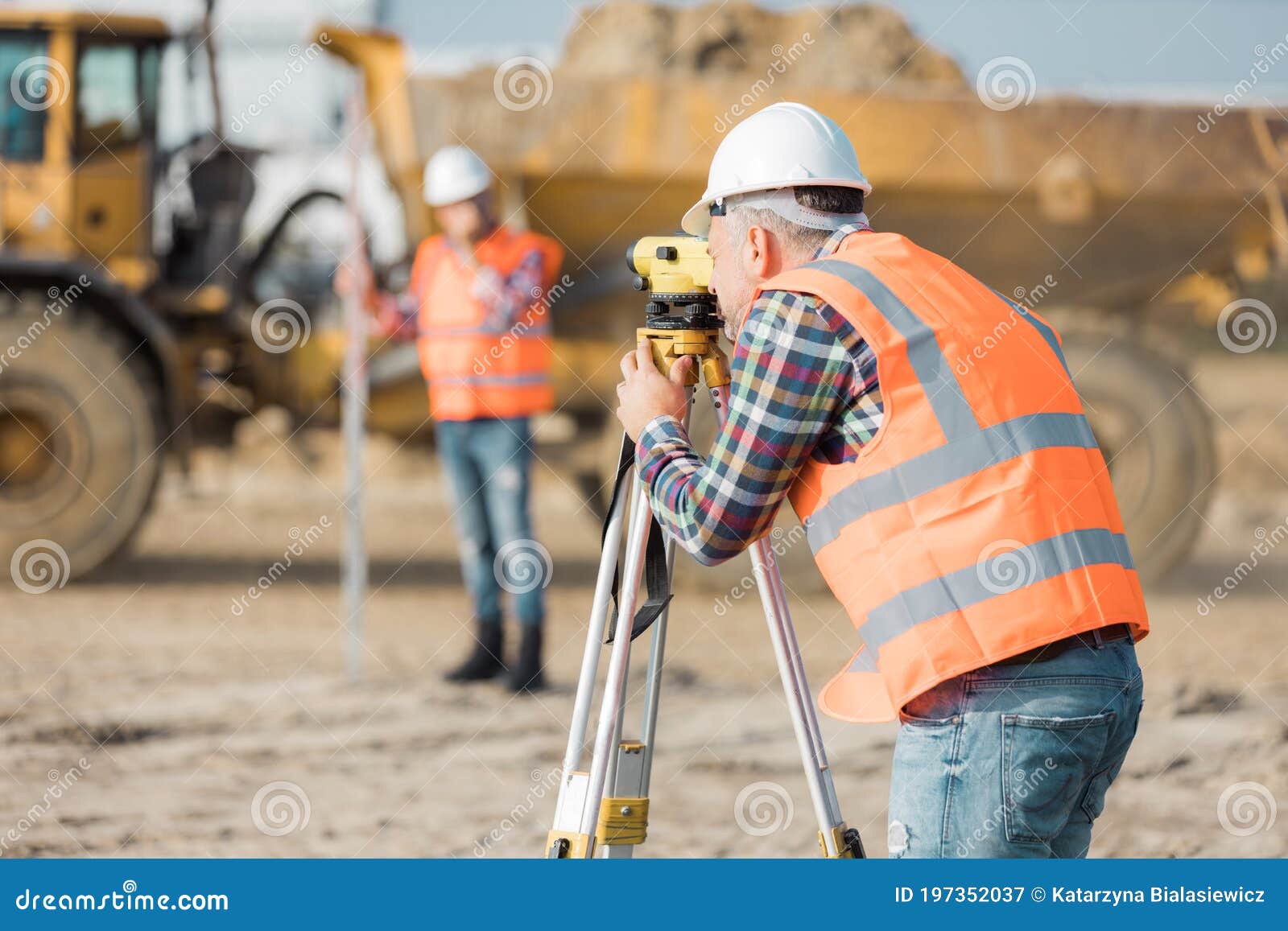 Two Construction Workers Using Measuring Device on the Field Stock ...
