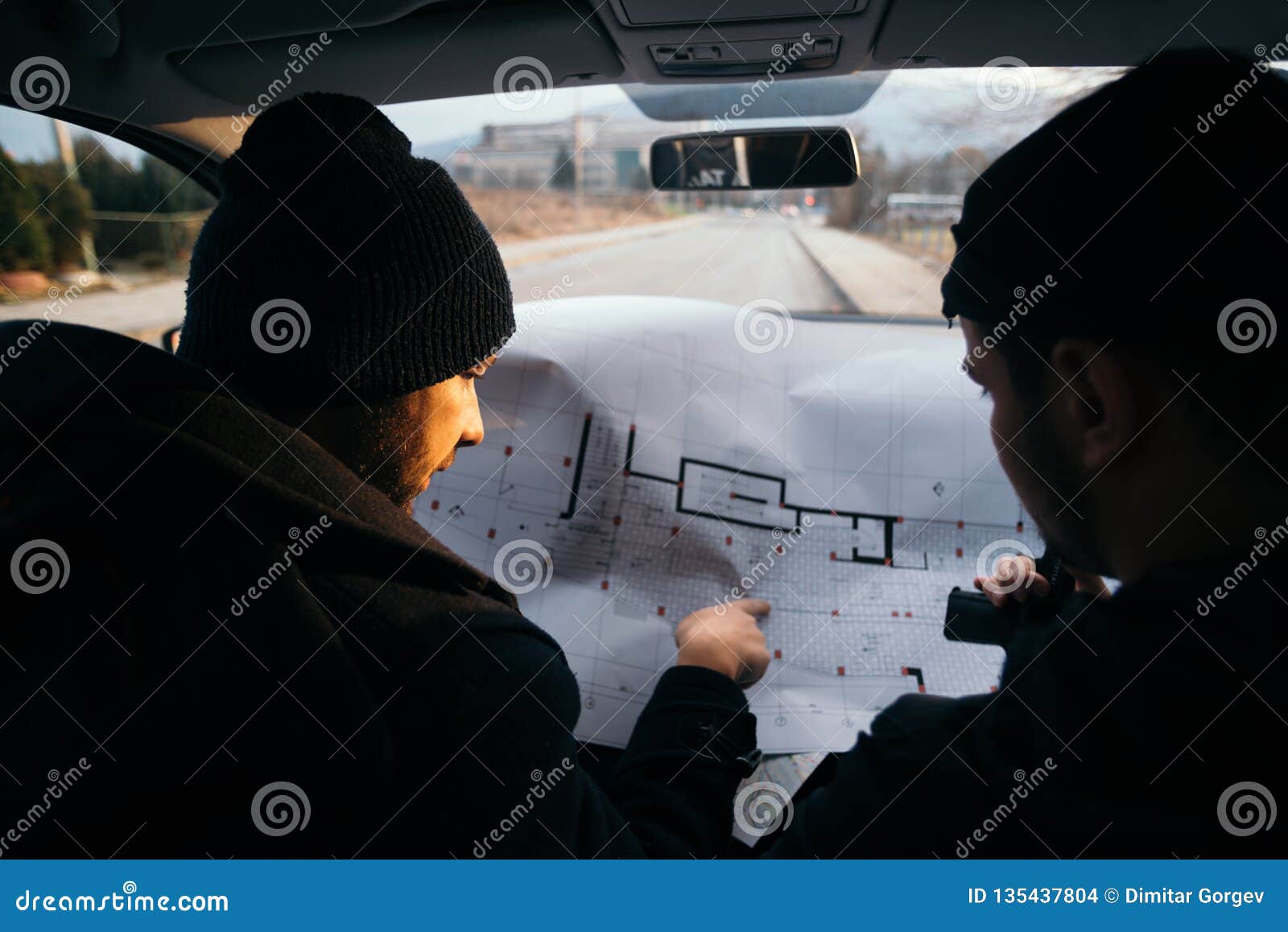 Two Robbers Planning and Pointing on the Blueprint Map Stock Photo ...