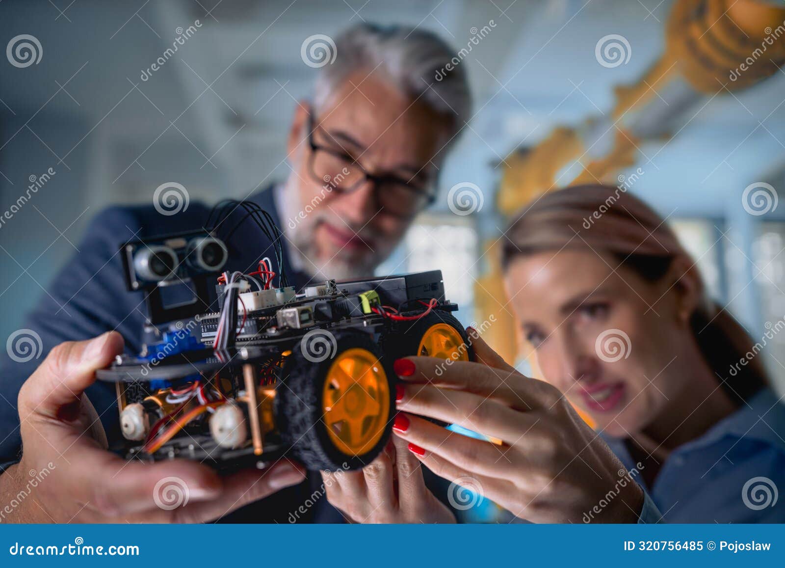 Two Robotics Engineers Assembling Robotic Car. Concept of Modern ...
