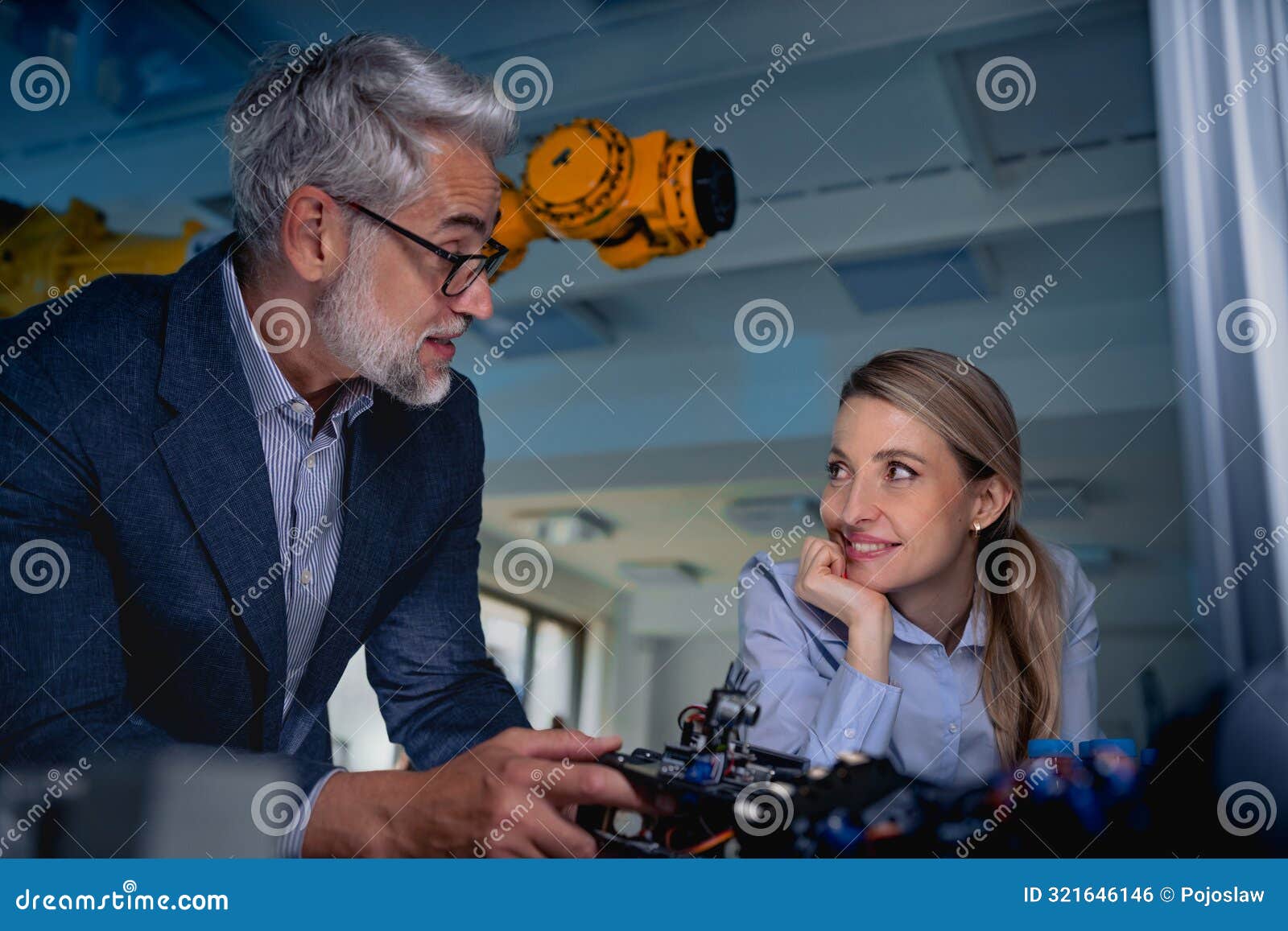 Two Robotics Engineers Working on New Project, Standing in Laboratory ...