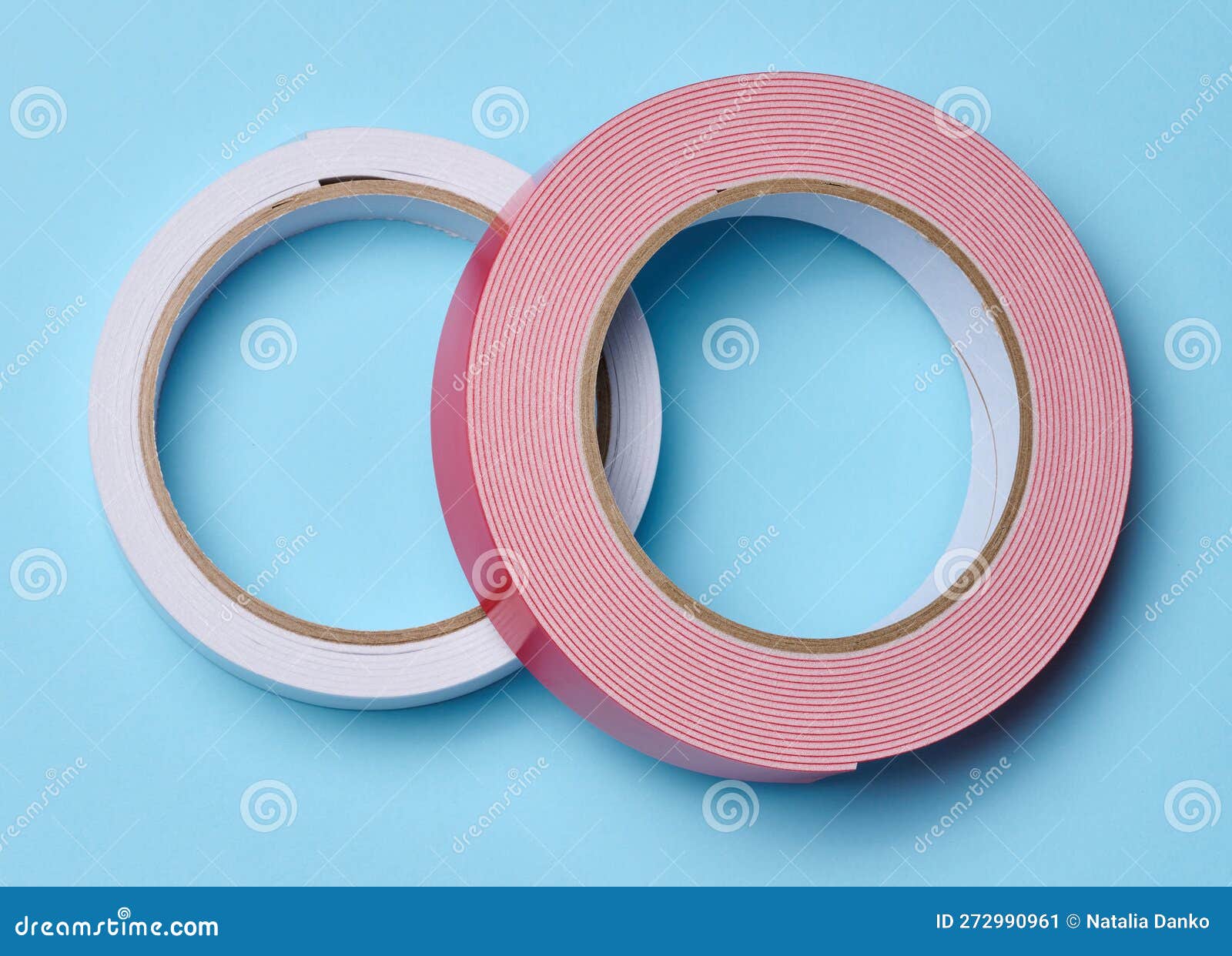 Two Rolls of Double-sided Sticky Tape on a Blue Background, Top View ...