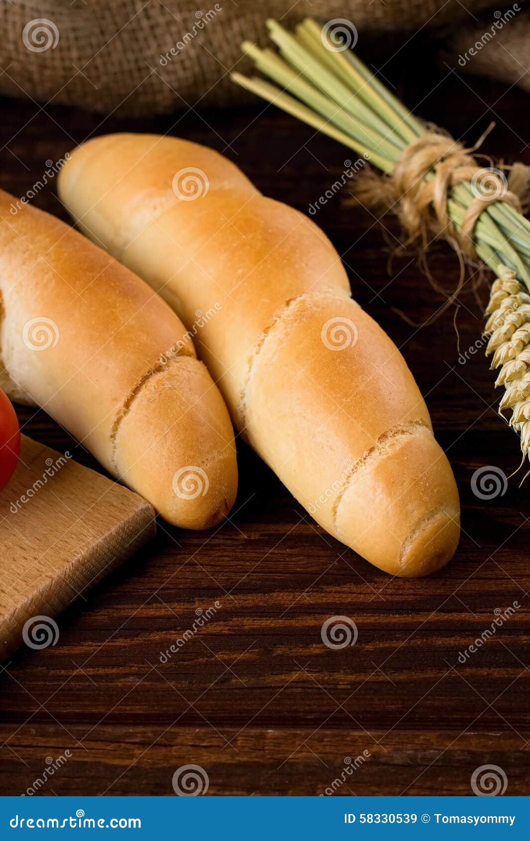 Two rolls on wooden board stock image. Image of bake - 58330539