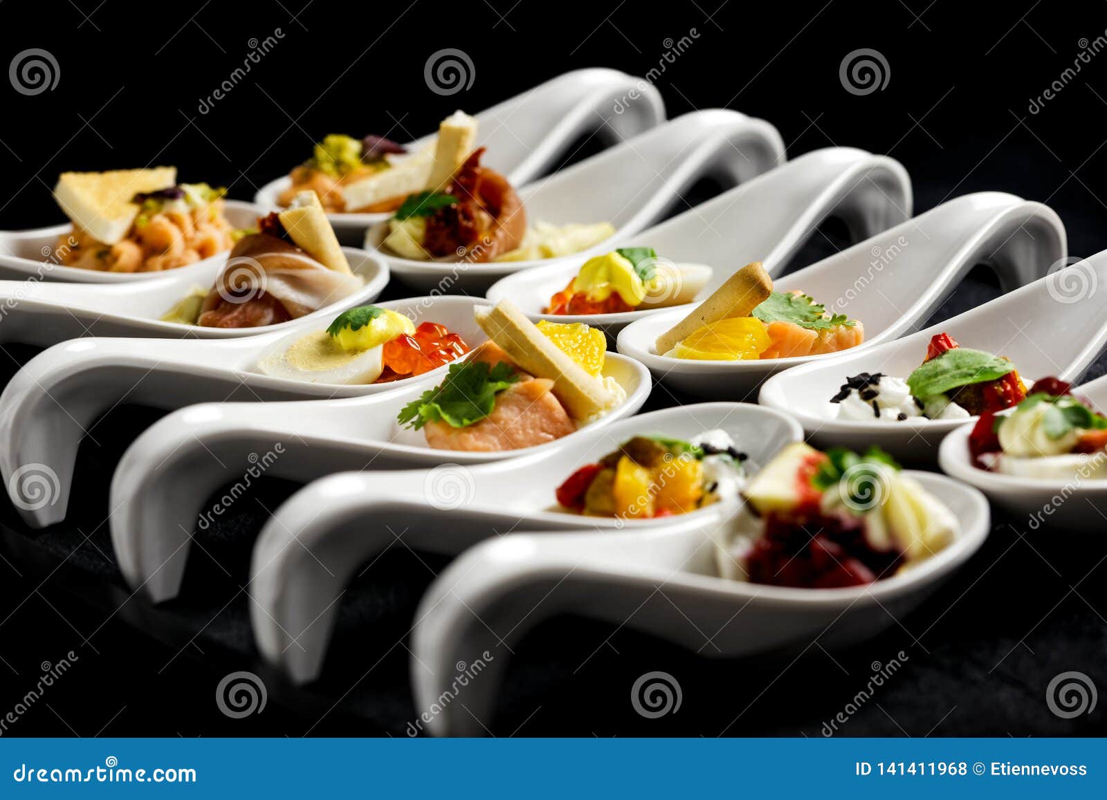Two Rows of Canapes on White Ceramic Spoons. Black Background Stock ...