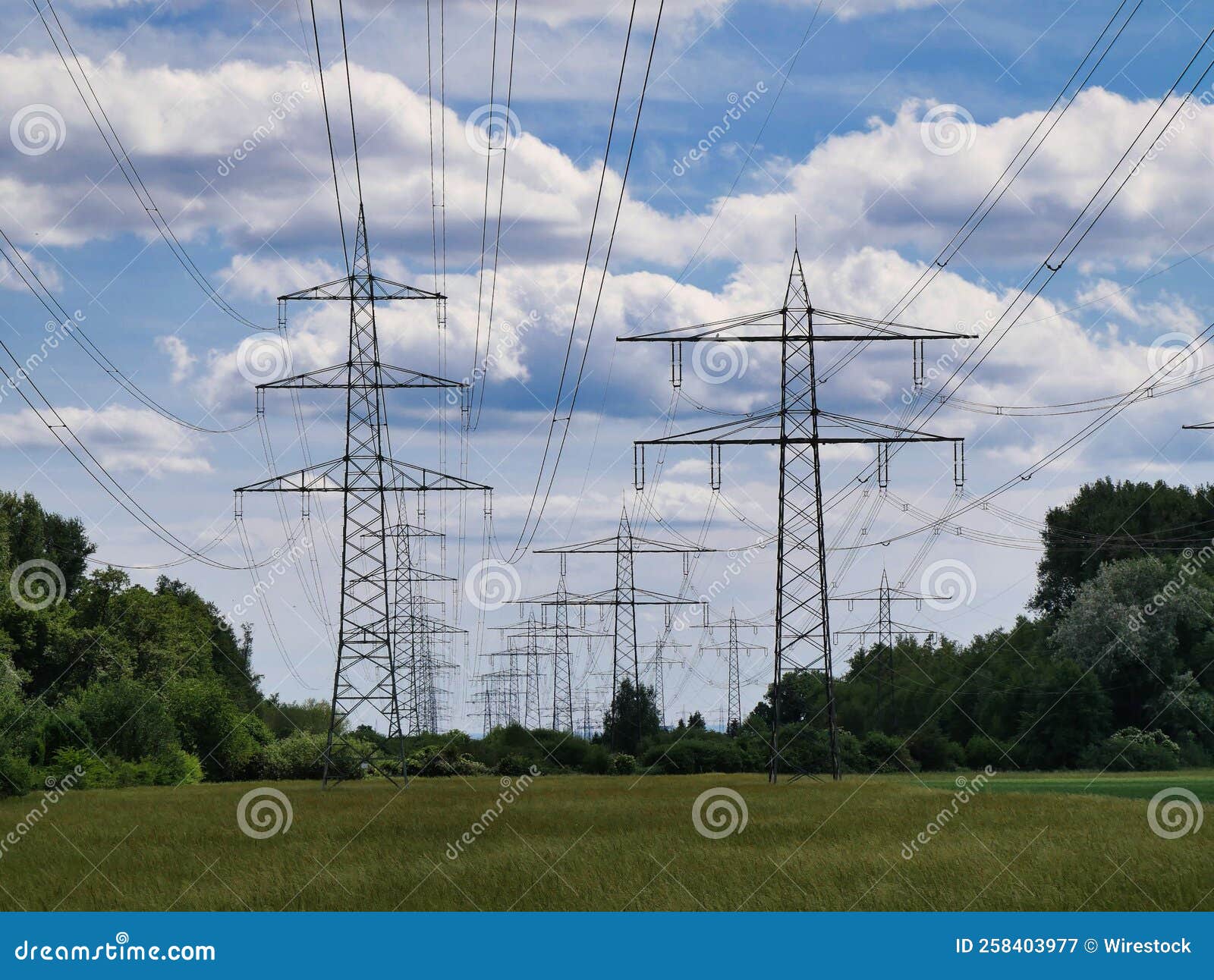 Rows of Electrical Transmission Towers on a Field Stock Image - Image ...