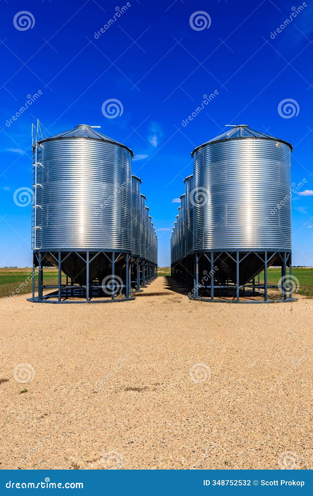 Two Rows of Large Metal Tanks are Lined Up in a Field Stock Photo ...