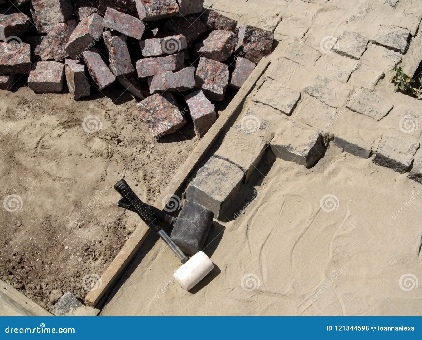 Two Rubber Mallets among a Pile of Granite Stones for Paving Stock ...