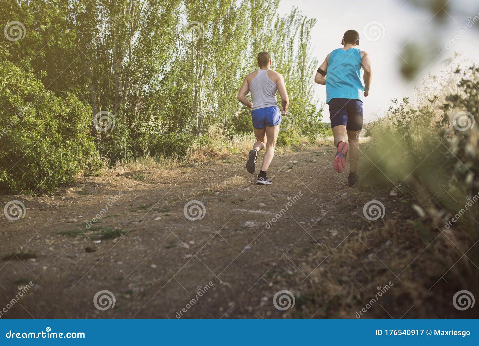 Two Runners Running Outdoors Stock Image - Image of back, young: 176540917
