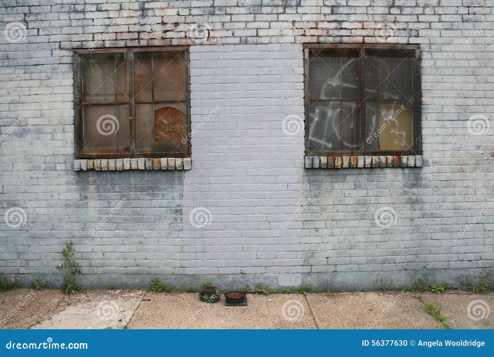 Two Rusty Metal Windows on Painted Brick Wall Stock Photo - Image of ...
