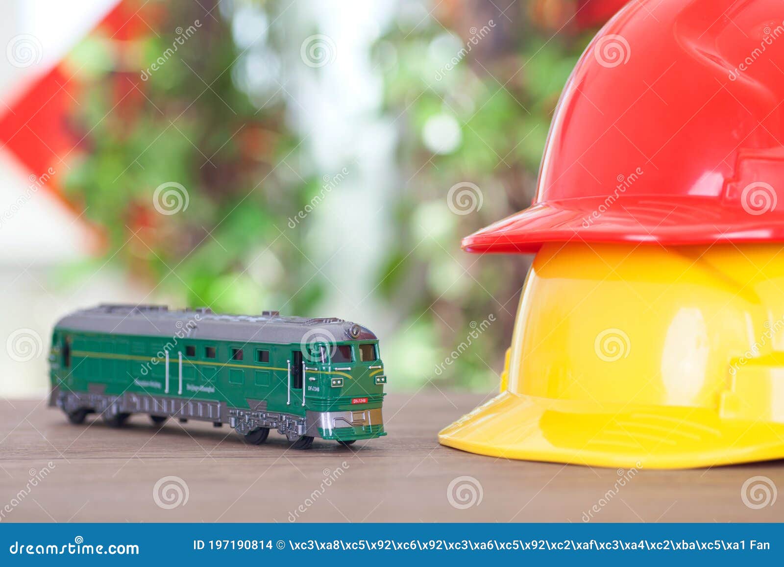 Two Safety Helmets and a Model Green Train on the Table Stock Photo ...
