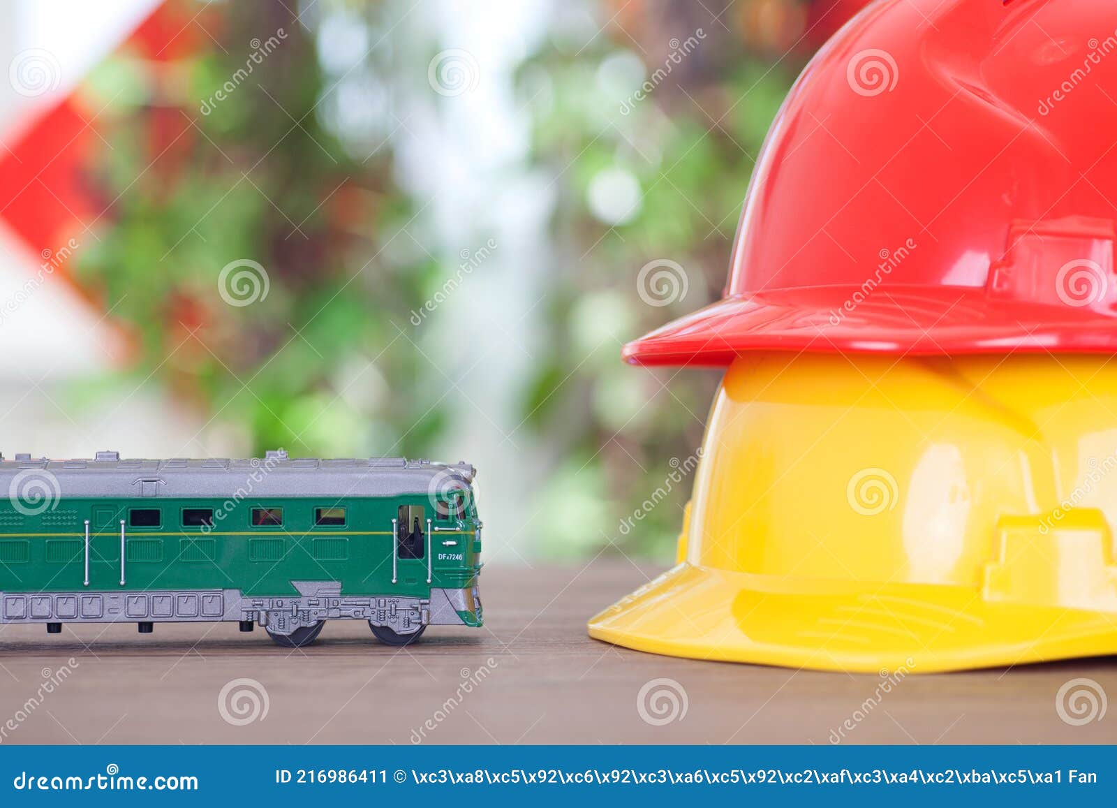 Two Safety Helmets and a Model Green Train on the Table Stock Image ...