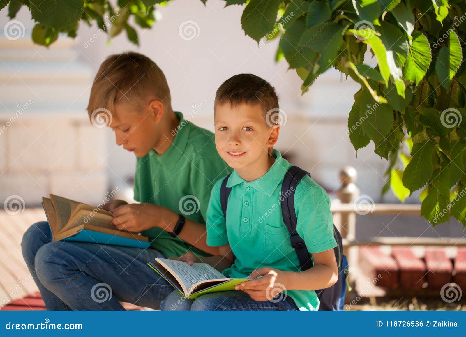 Two School Children Sit Under a Tree and Read Books on a Sunny Summer ...