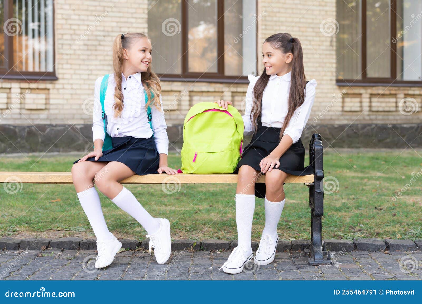 Two School Girls Friends Sit on Bench with Backpack Together Stock ...