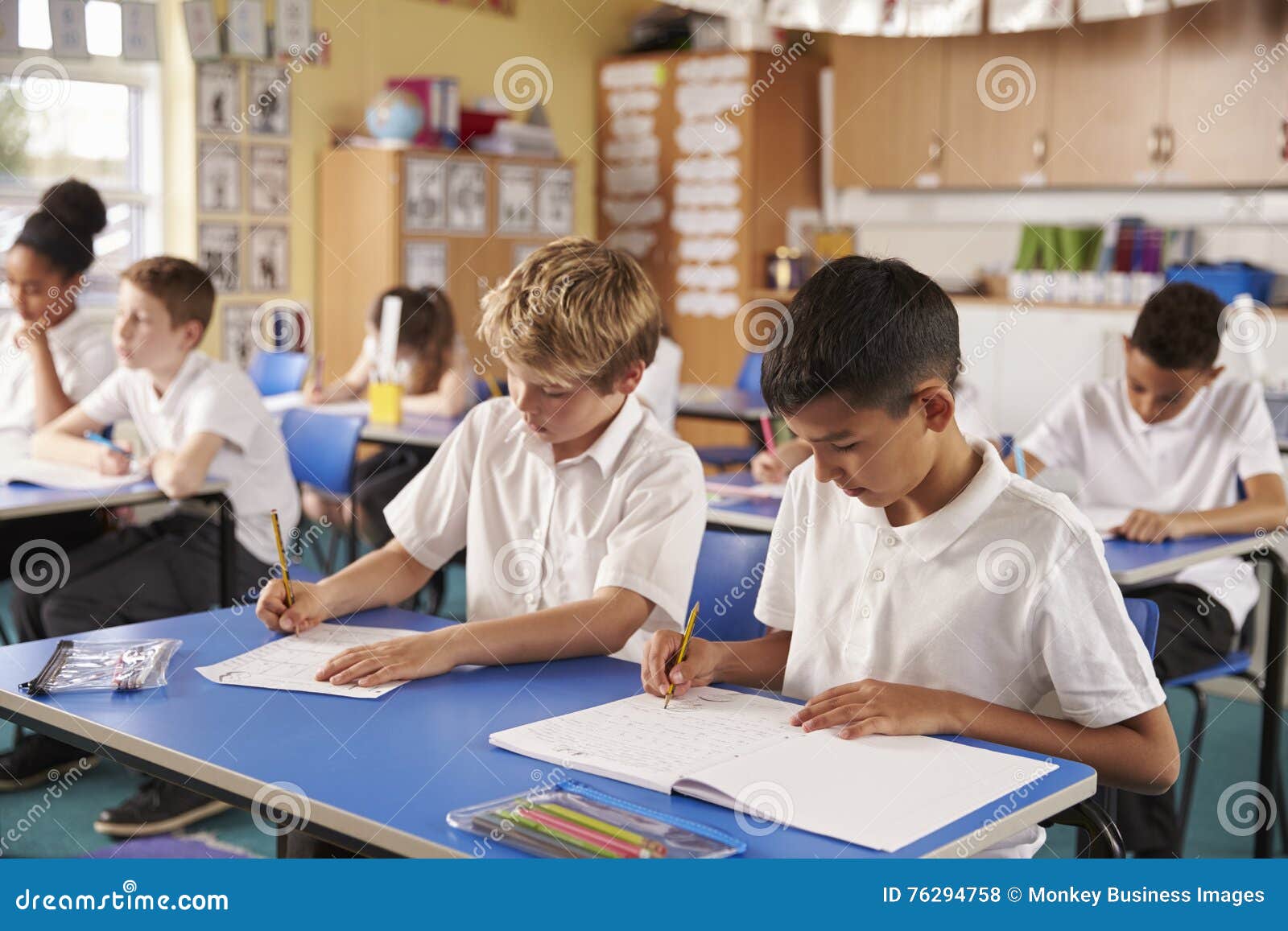 Two Schoolboys Working in a Primary School Class Stock Photo - Image of ...