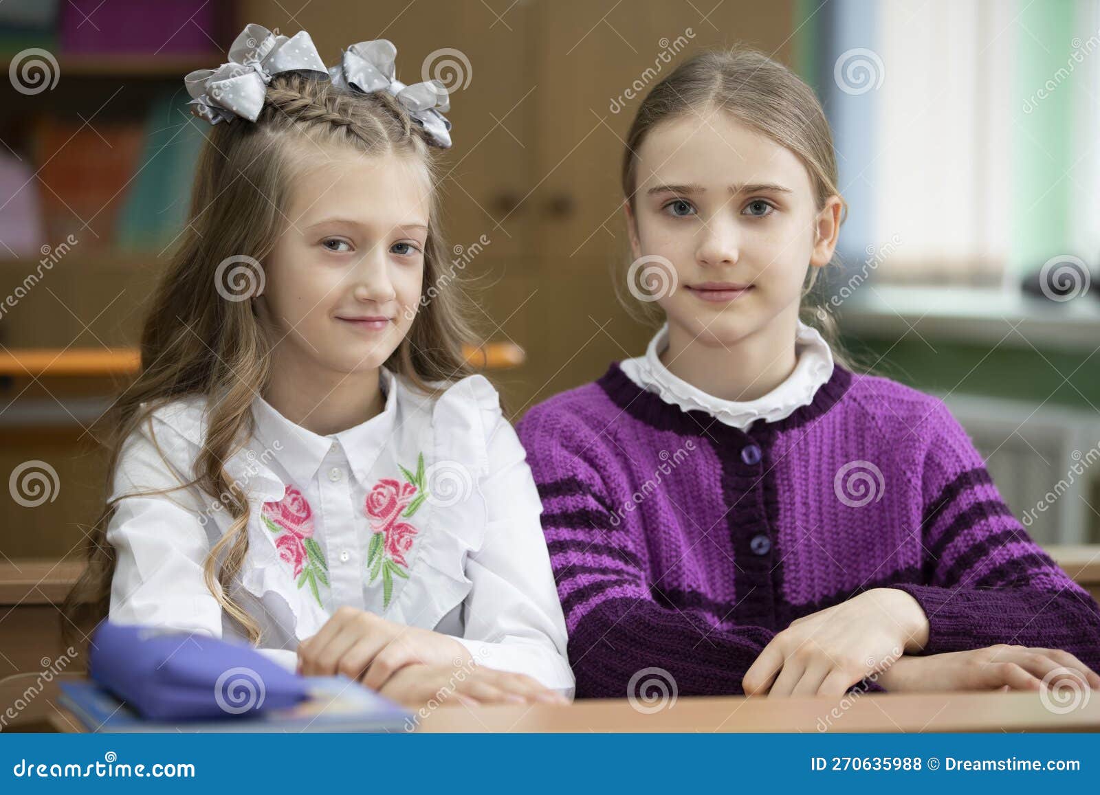 Two Schoolgirls Sit at a Desk in the Classroom Stock Photo - Image of ...