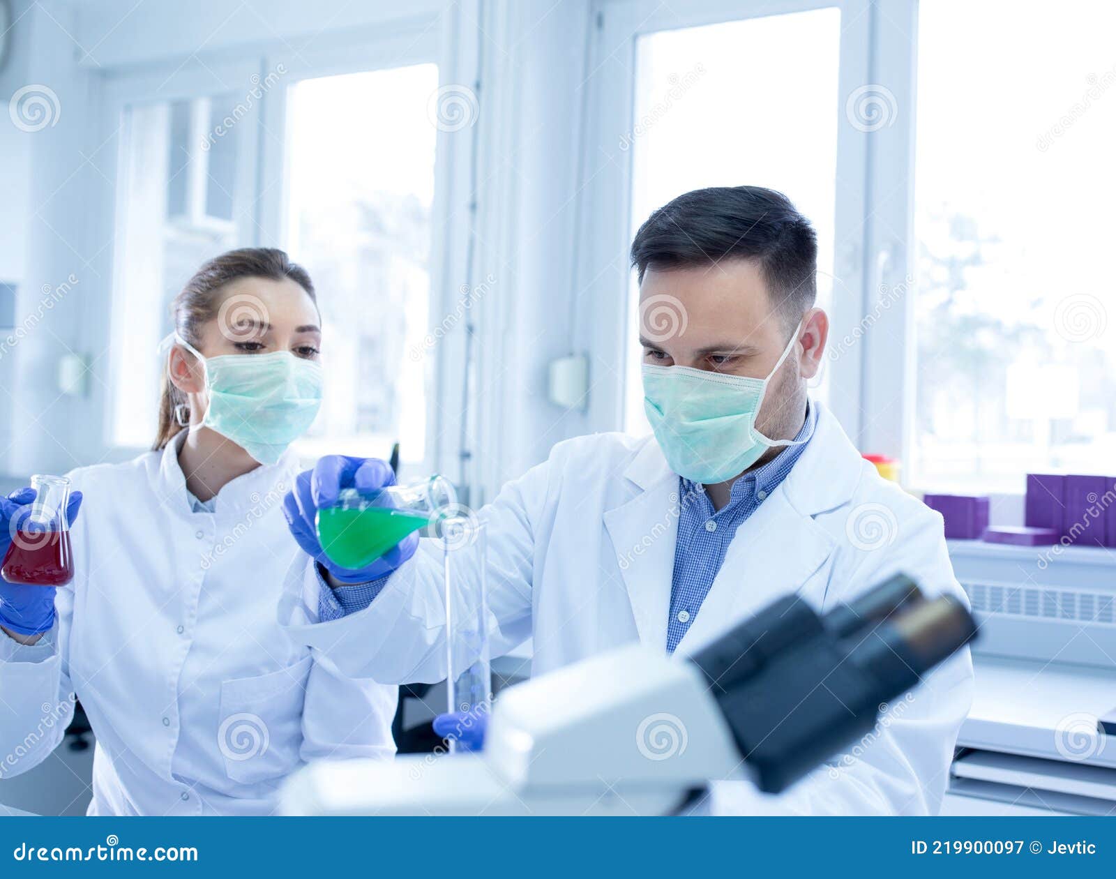 Two Scientists Doing Experiments Using Erlenmeyer Flask and Lab ...