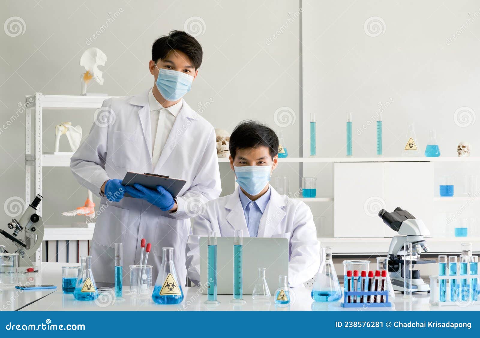 Two Scientists with Face Mask and Gown Working in Laboratory. Omicron ...