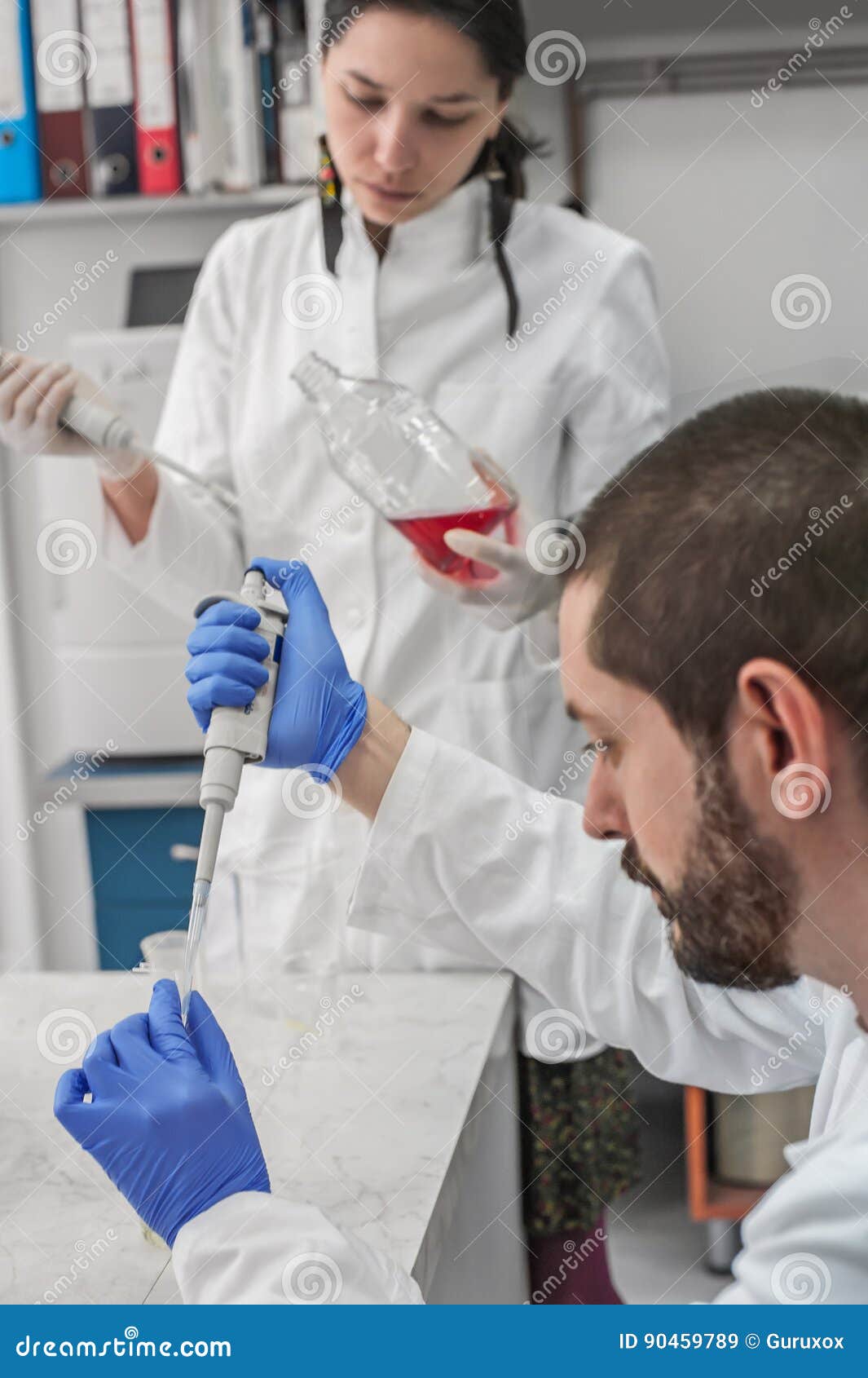 Two Scientists in the Laboratory Filling Test Tubes with Pipette Stock ...