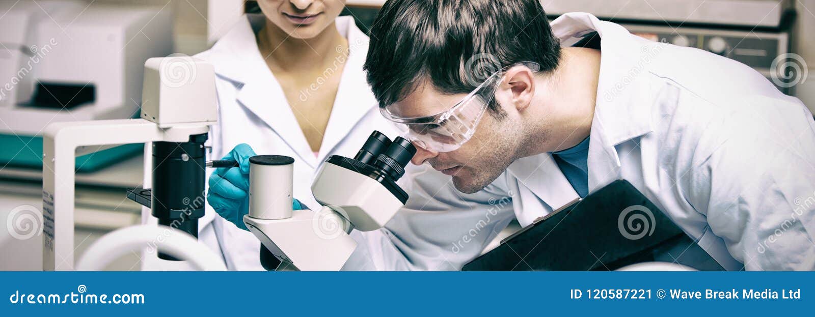 Two Scientists Observing Something With Microscope Stock Photo ...