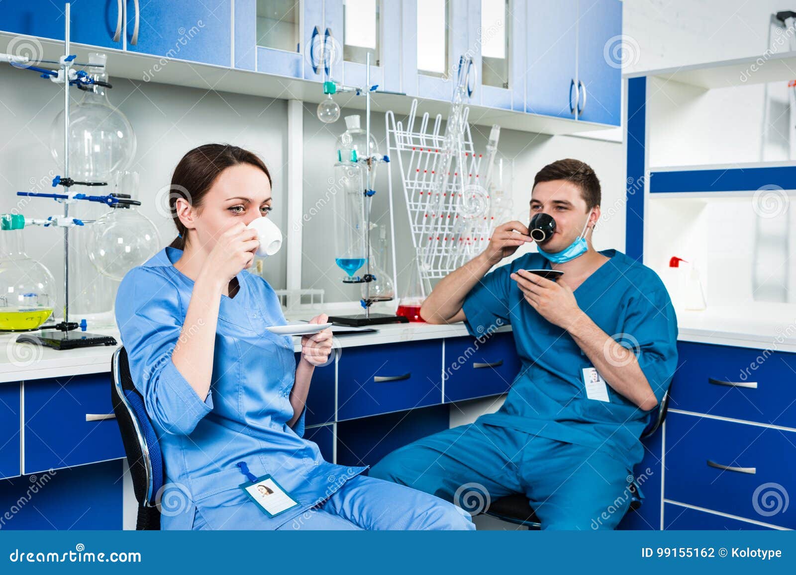 Two Scientists in Uniform Drinking a Coffee after Some Research Stock ...