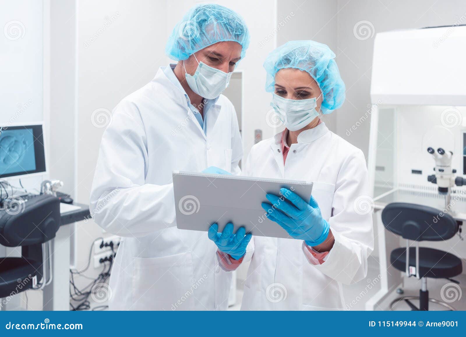Two Scientists Working Together in Lab Looking at Data Stock Photo ... Two Scientists Working Together in Lab Looking at Data Stock Photo ...