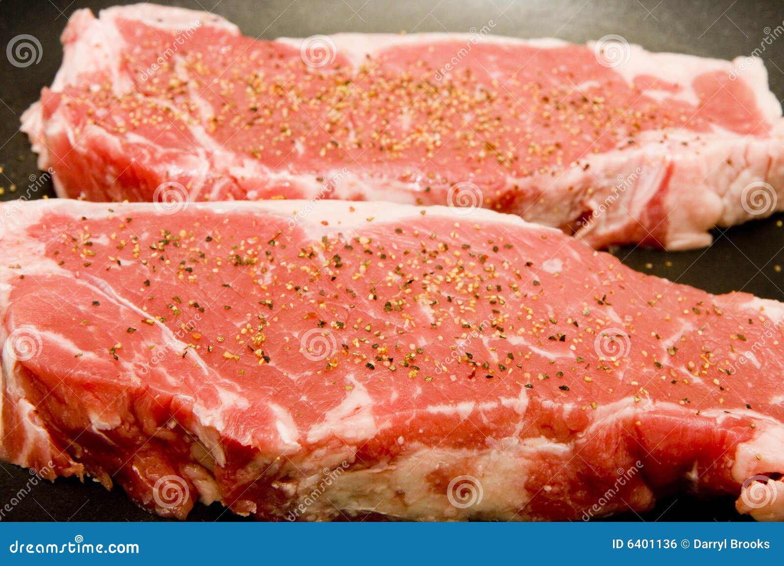 Two Seasoned Strip Steaks stock photo. Image of skillet - 6401136