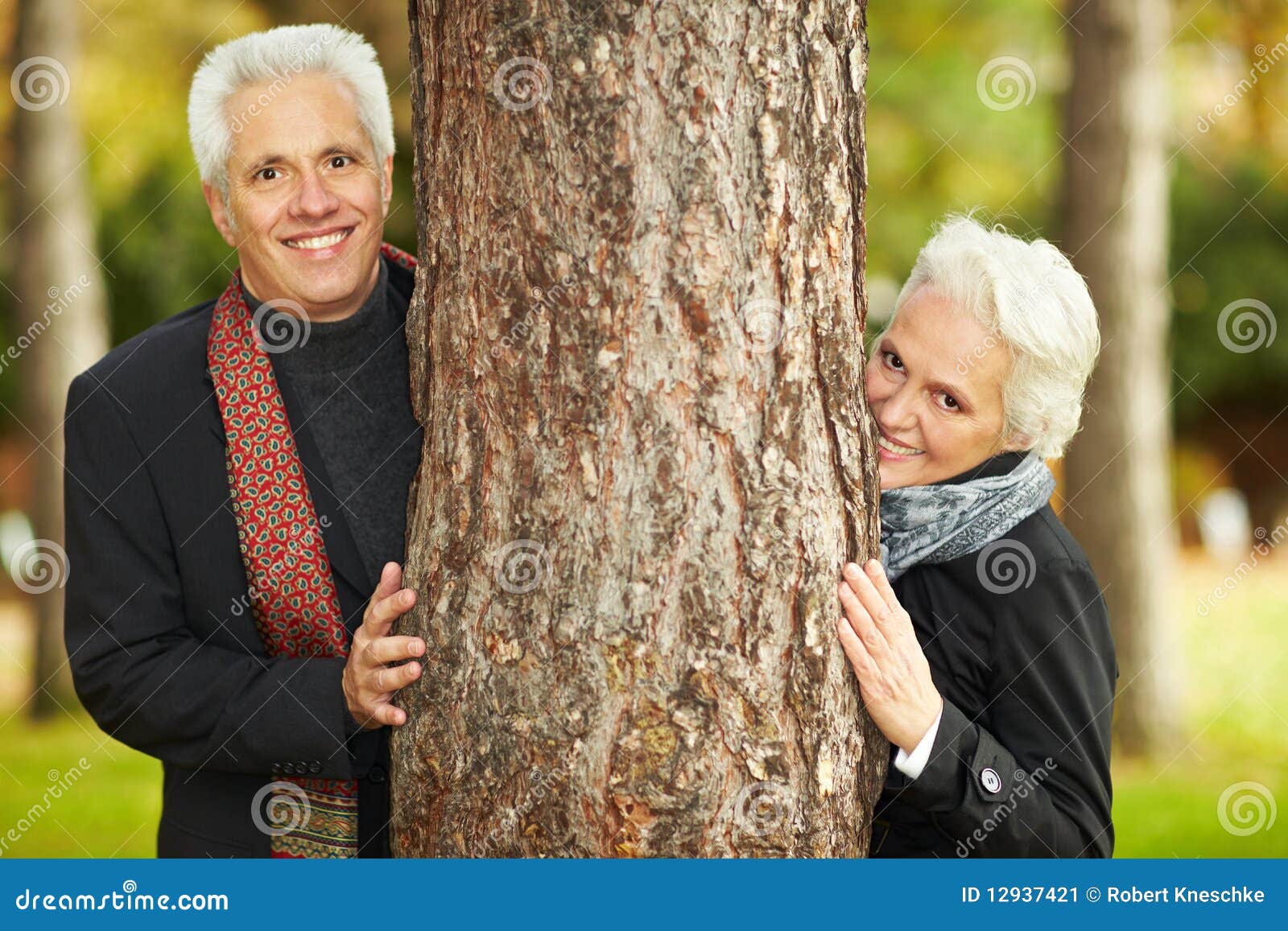Two Senior Citizens Behind a Tree Stock Image - Image of senior, happy ...
