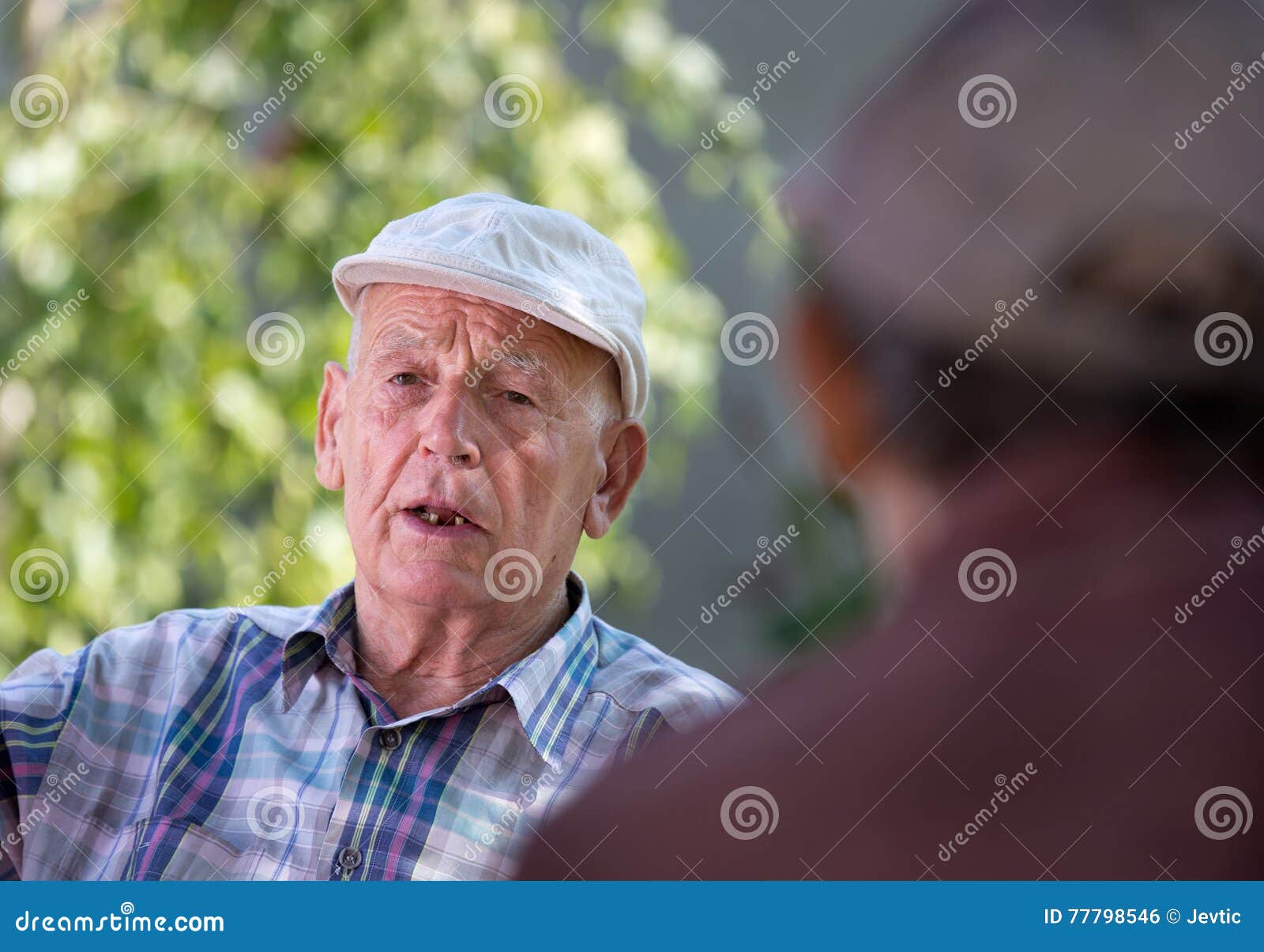 Two Senior Citizens Chatting Stock Photo - Image of chatting, green ...