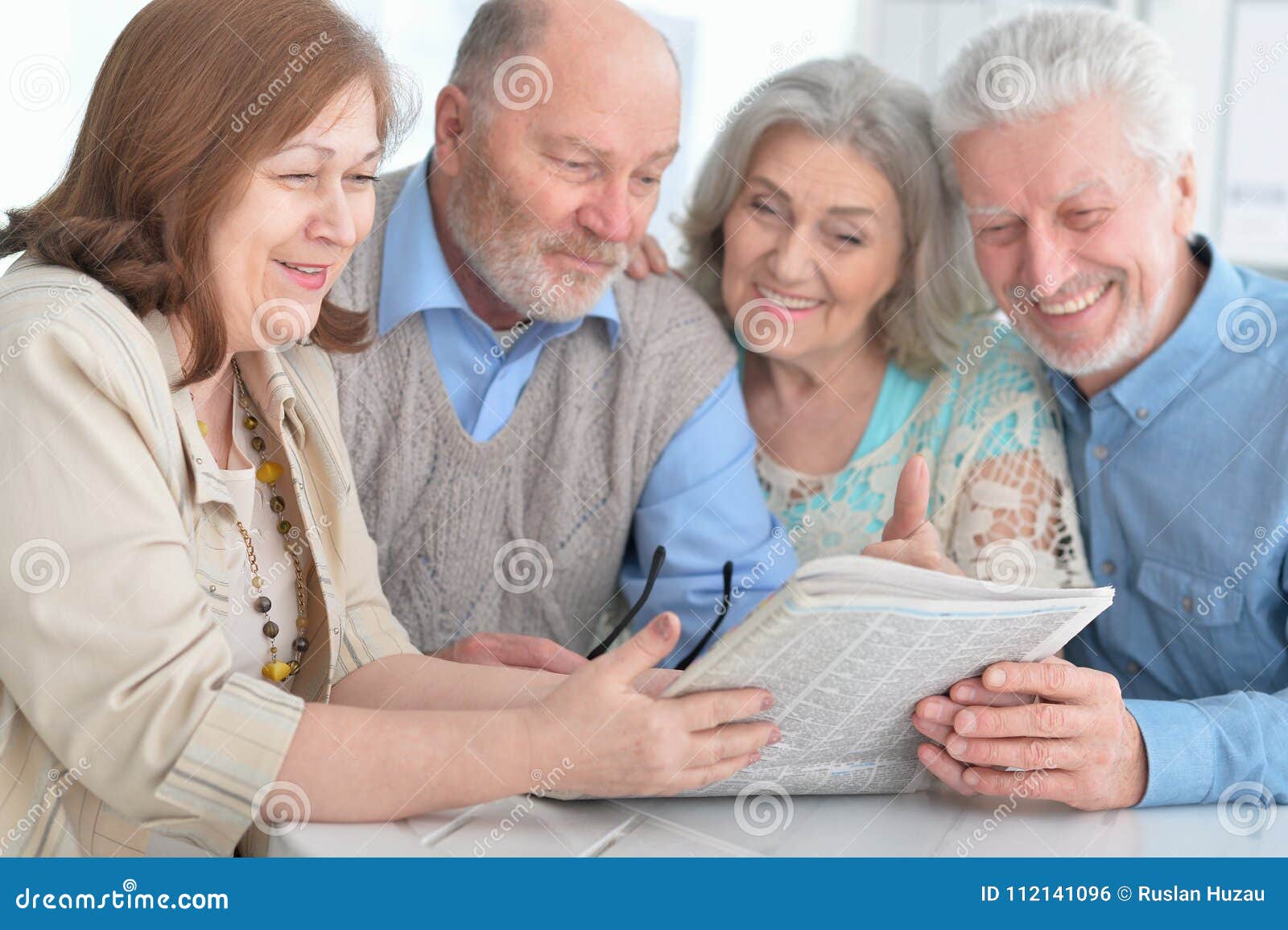 Two Senior Couples Reading Newspaper Stock Photo - Image of happiness ...