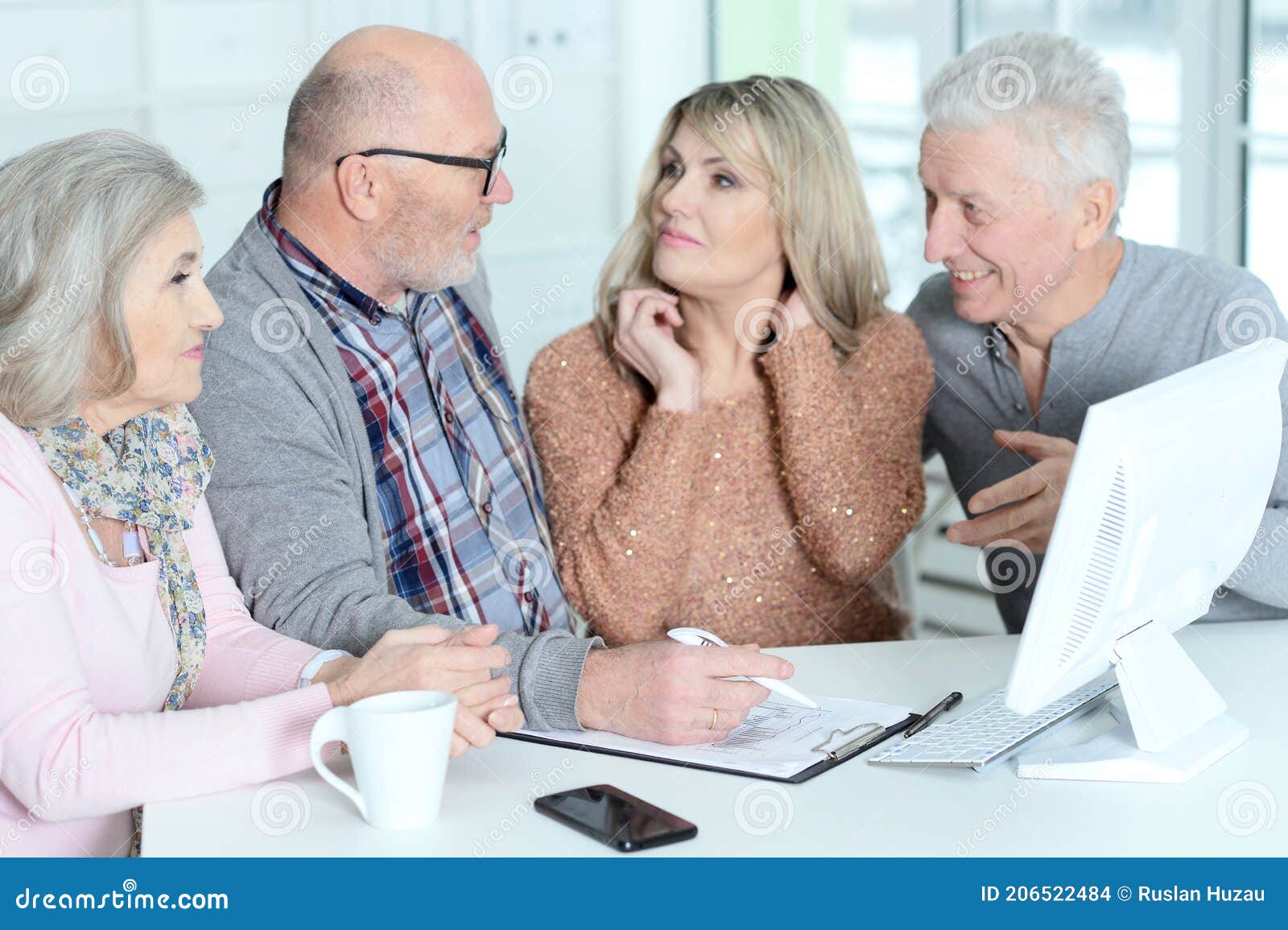 Two Senior Couples Sitting at Table and Working with Computer Stock ...