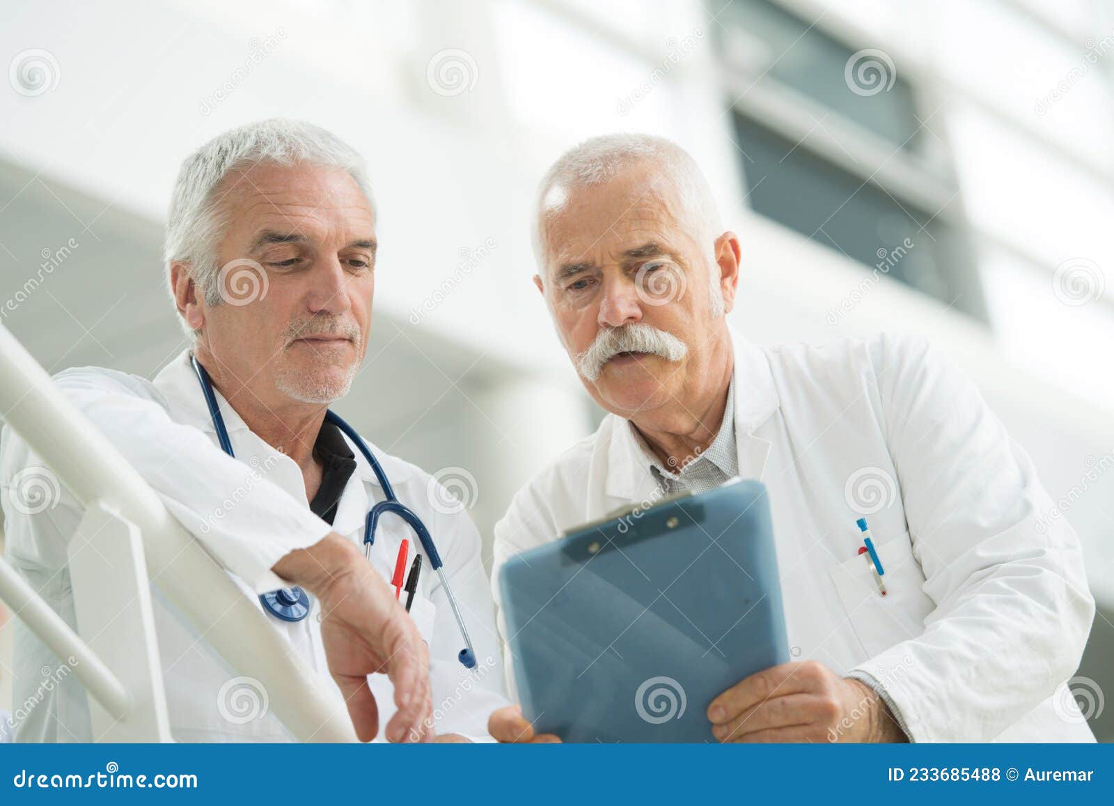 Two Senior Doctors Talking Together Stock Photo - Image of talking ...