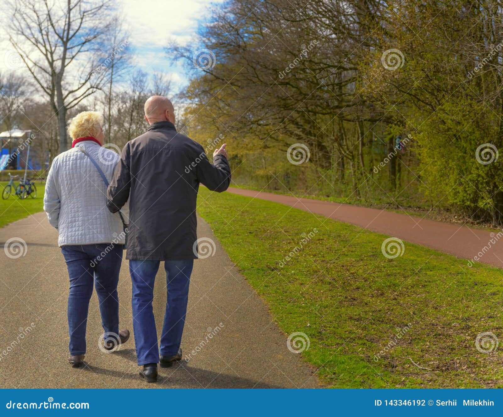 Two Seniors Walking in Spring Park Stock Photo - Image of couple ...