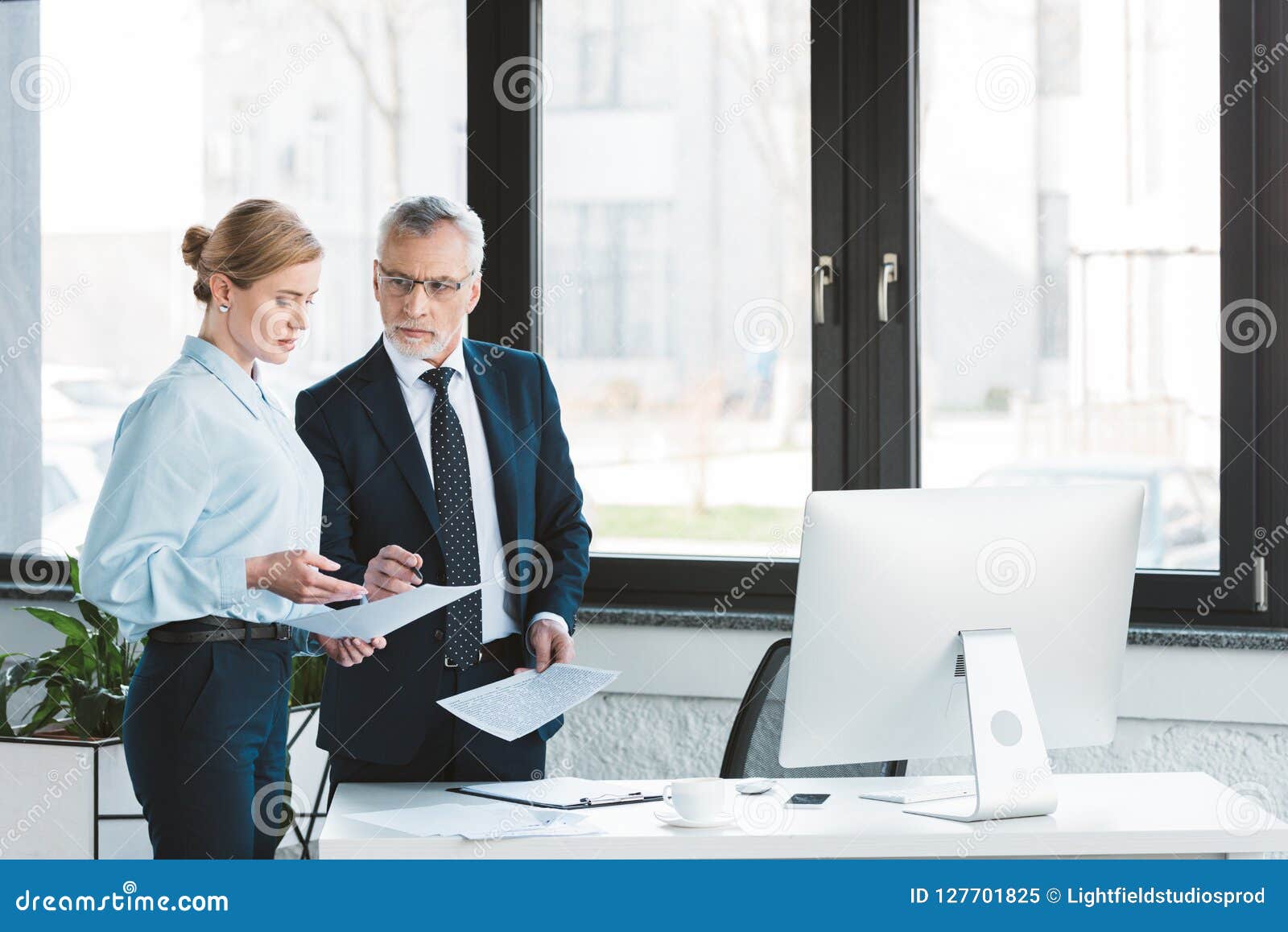 Two Serious Business Colleagues Discussing Papers Stock Image - Image ... Two Serious Business Colleagues Discussing Papers Stock Image - Image ...
