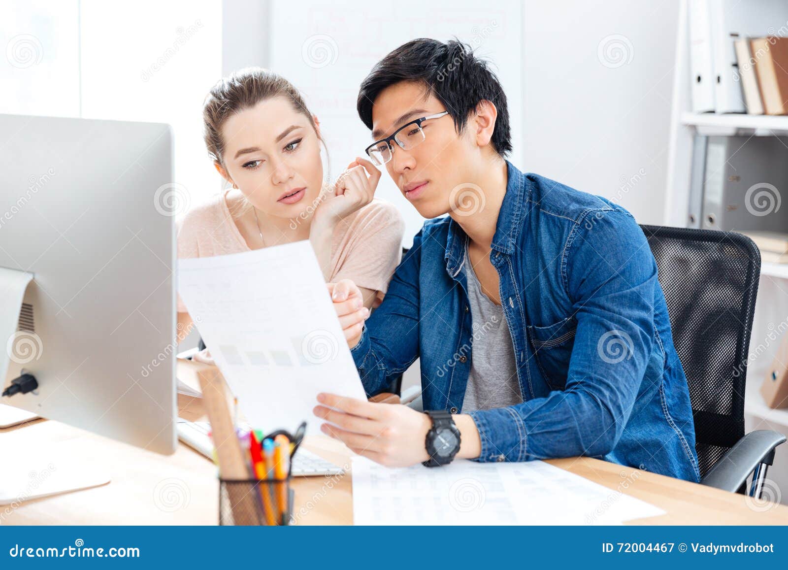 Two Serious Businesspeople Working with Documents in Office Stock Image ...