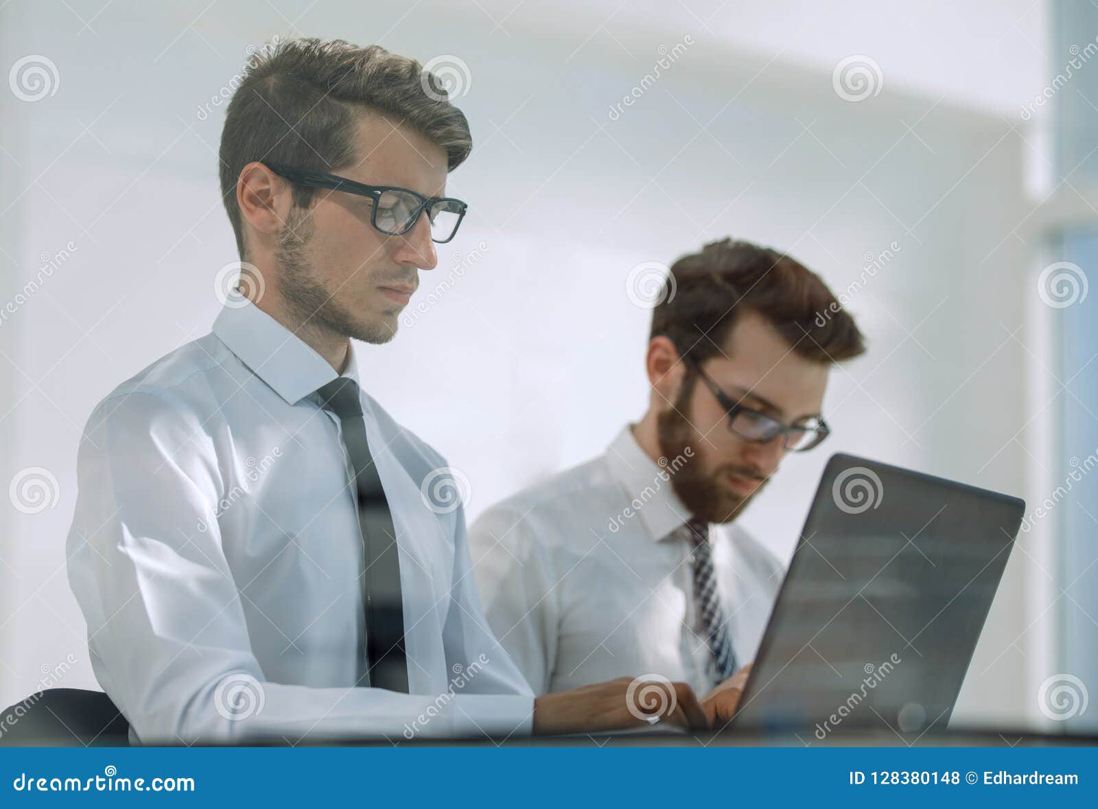Two Serious Employees Work on Laptops in the Office. Stock Photo ...