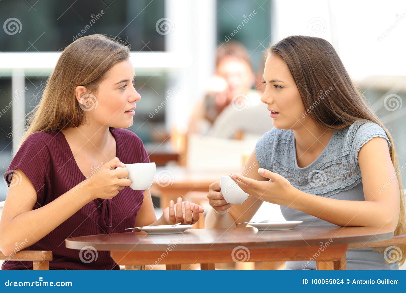 Serious Friends Talking in a Restaurant Stock Photo - Image of friends ... Serious Friends Talking in a Restaurant Stock Photo - Image of friends ...