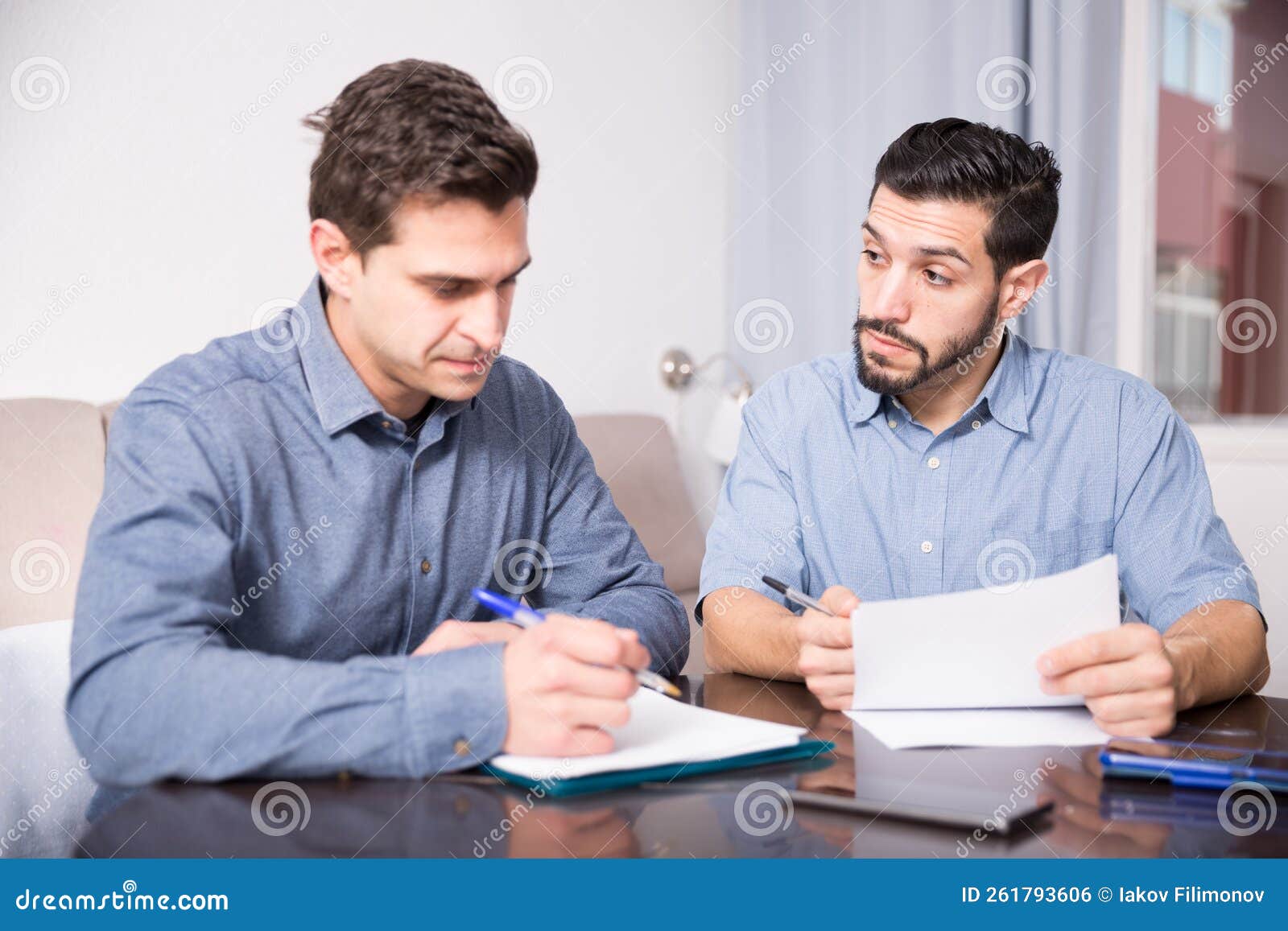Two Serious Men with Documents at Table Stock Photo - Image of ...