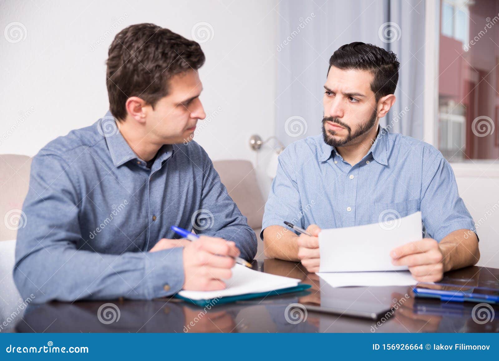 Two Serious Men with Documents at Table Stock Photo - Image of group ...