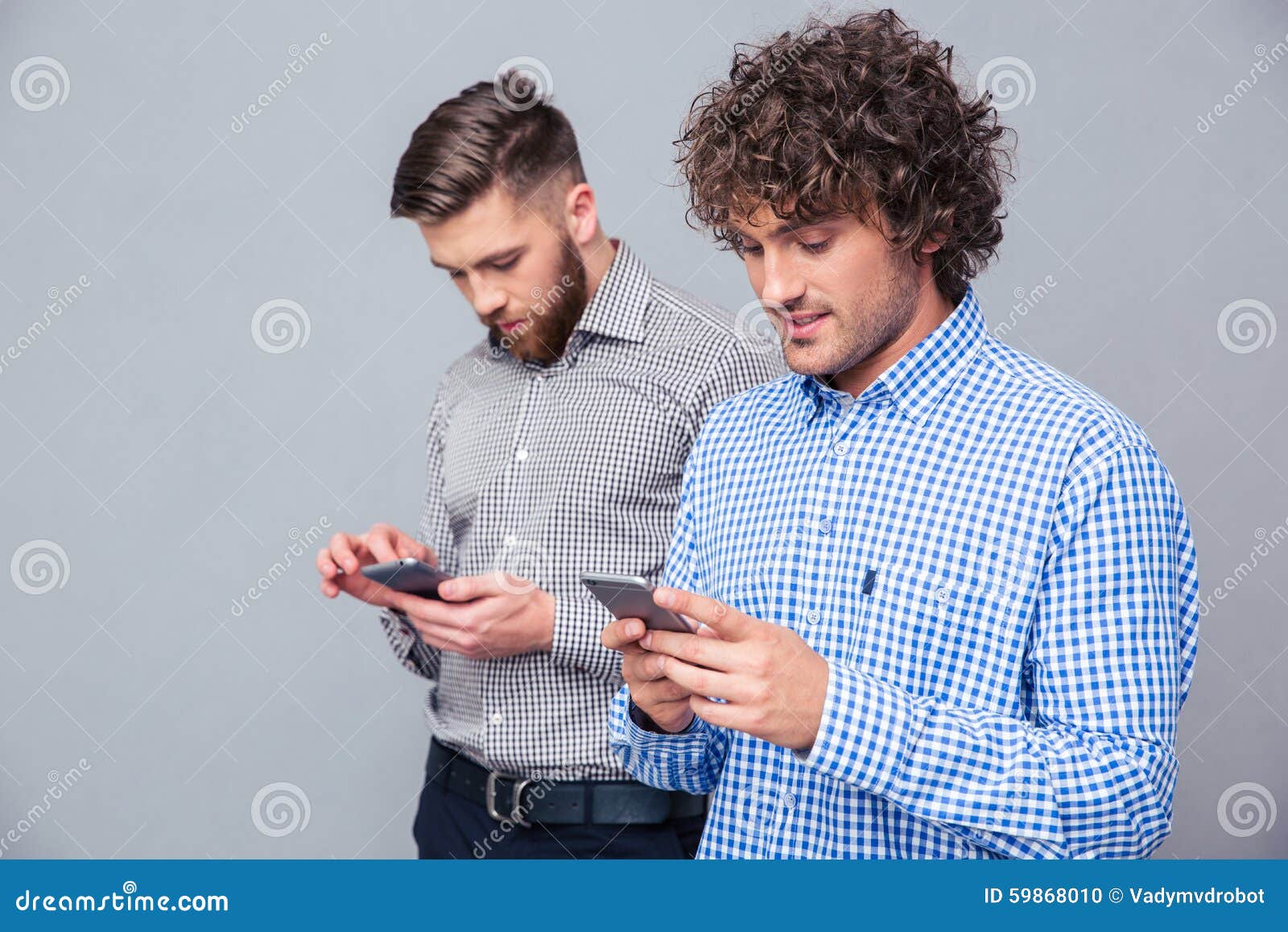 Two Serious Men Using Smartphone Stock Photo - Image of lifestyle ...