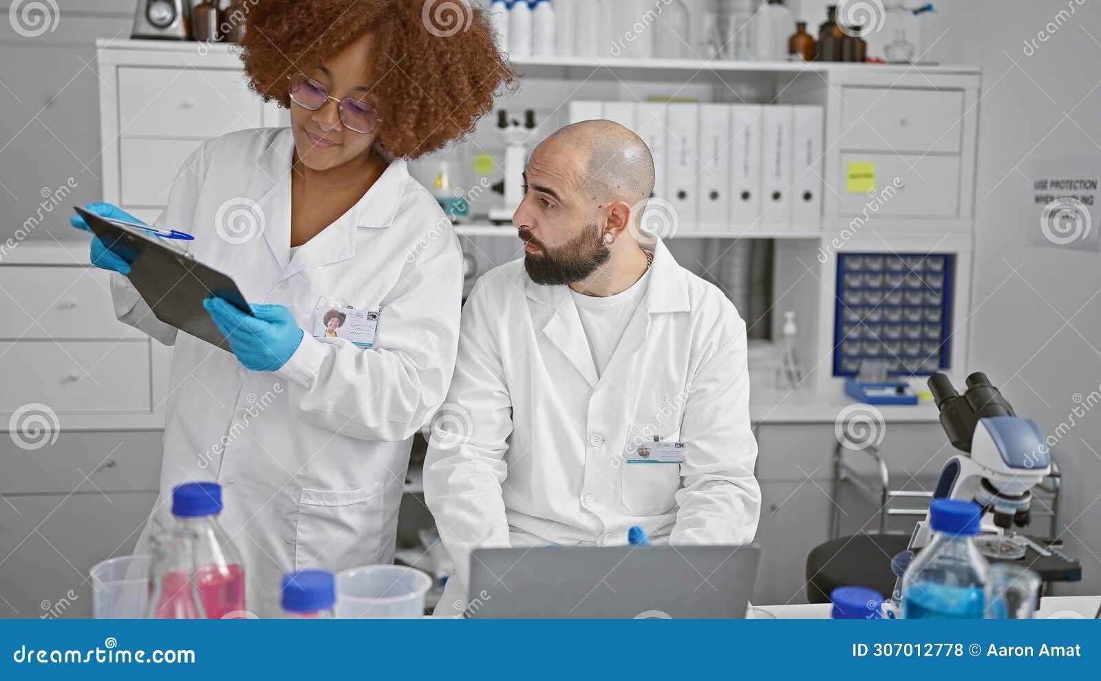 Two Serious Scientists at the Lab, High-tech Laptop and Clipboard in ...