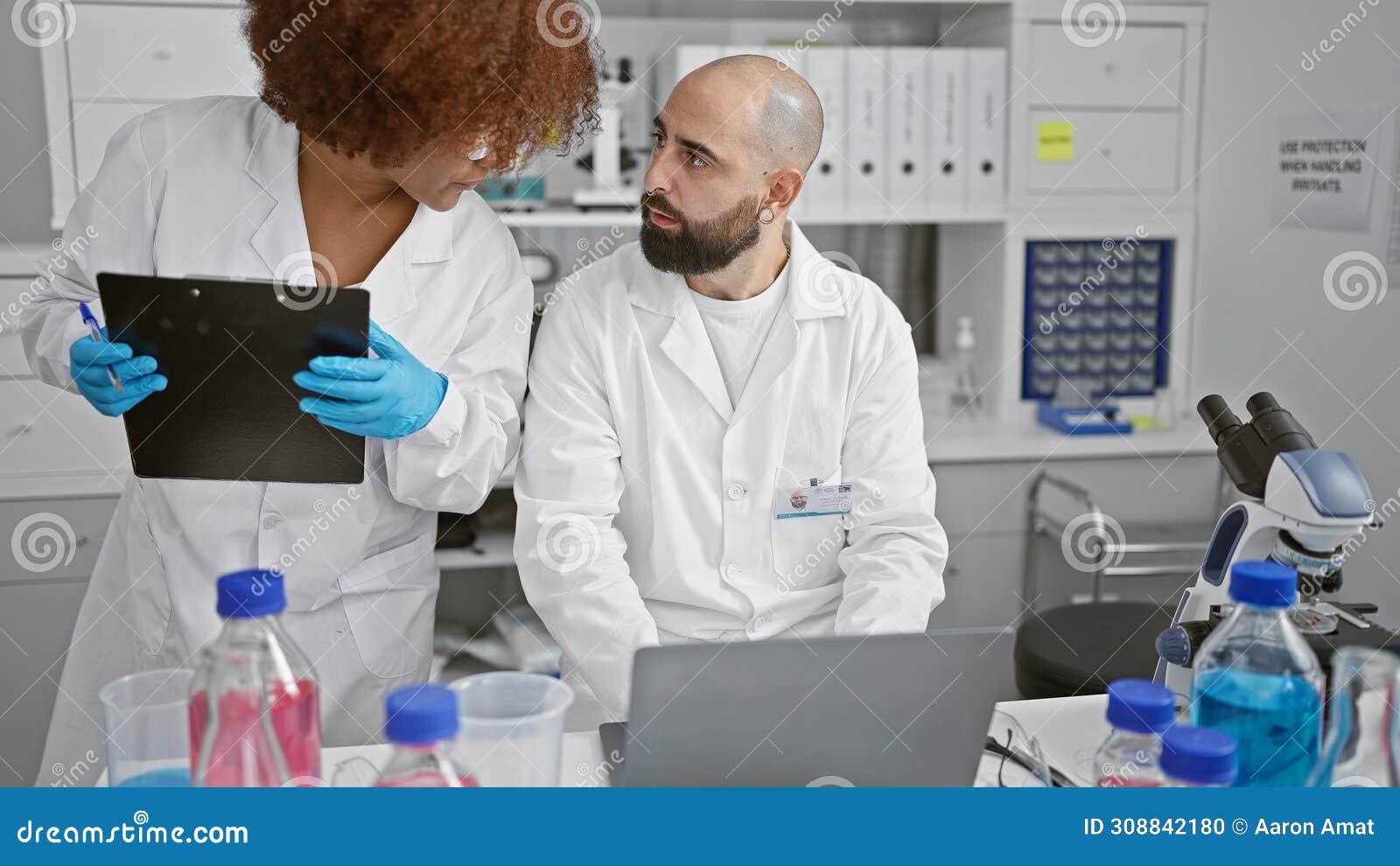 Two Serious Scientists at the Lab, High-tech Laptop and Clipboard in ...